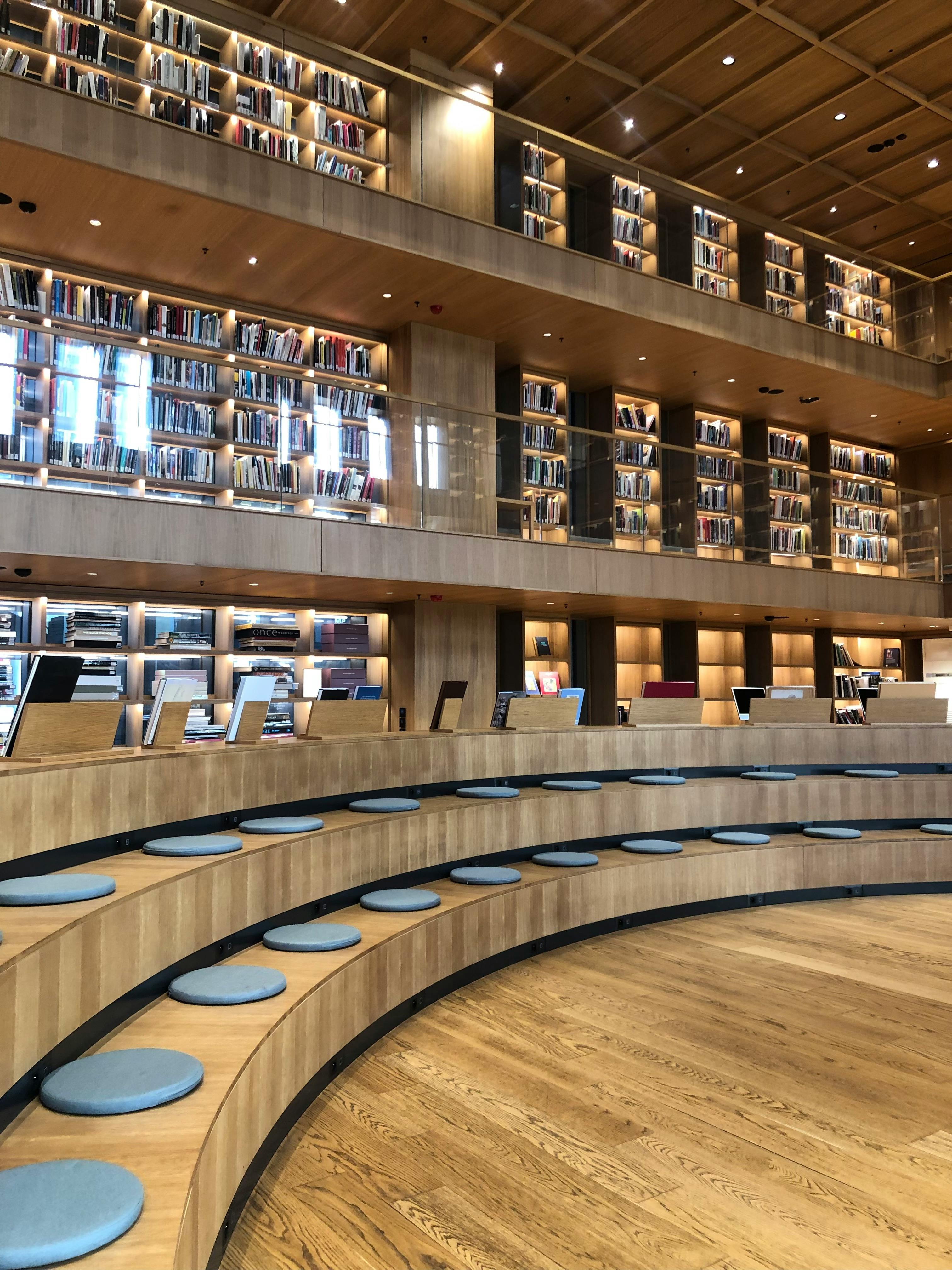 Modern wooden library interior with seating · Free Stock Photo
