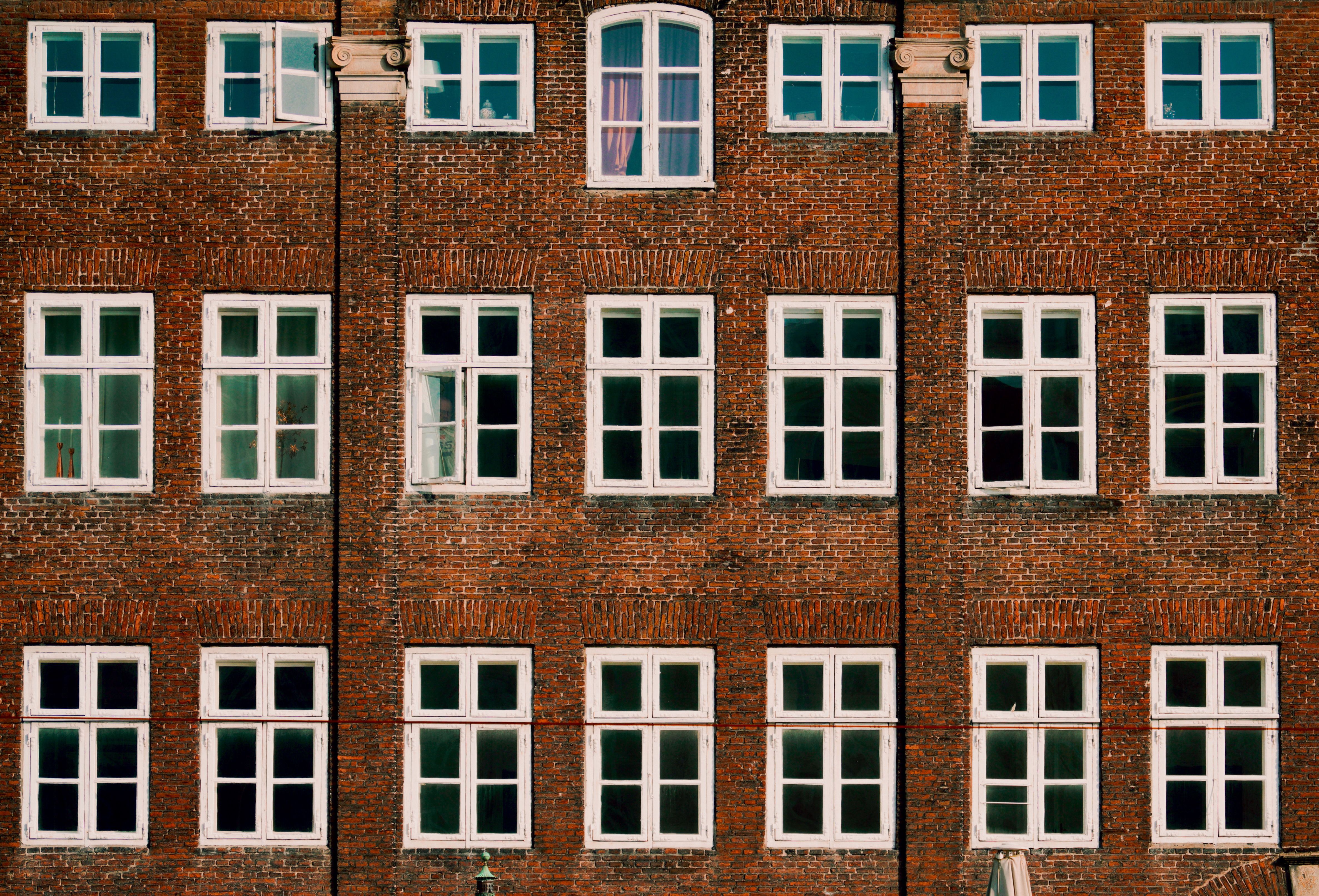 Historic Brick Facade with White Windows in Copenhagen · Free Stock Photo
