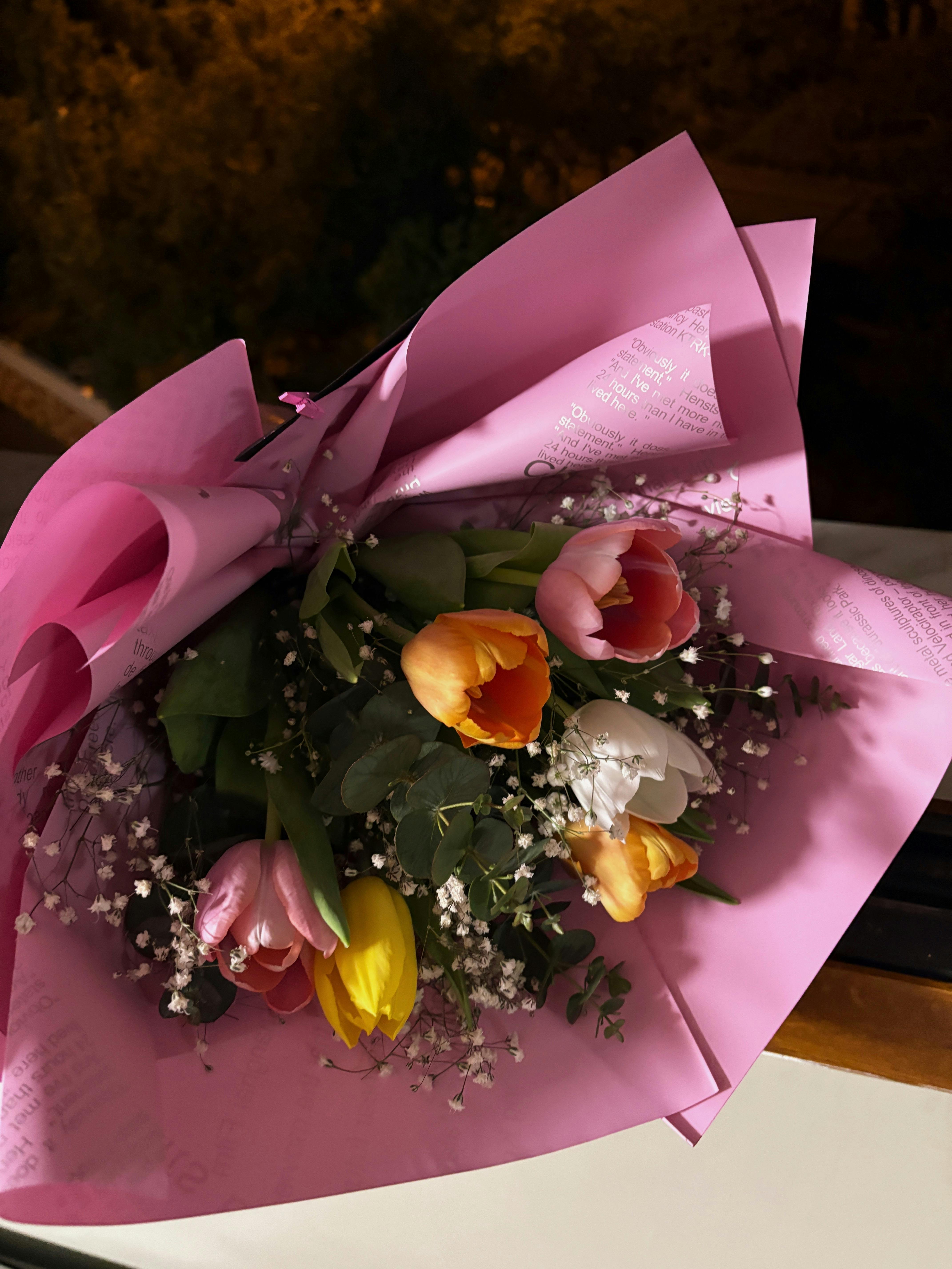 Elegant Bouquet of Tulips with Pink Wrap Outdoors · Free Stock Photo