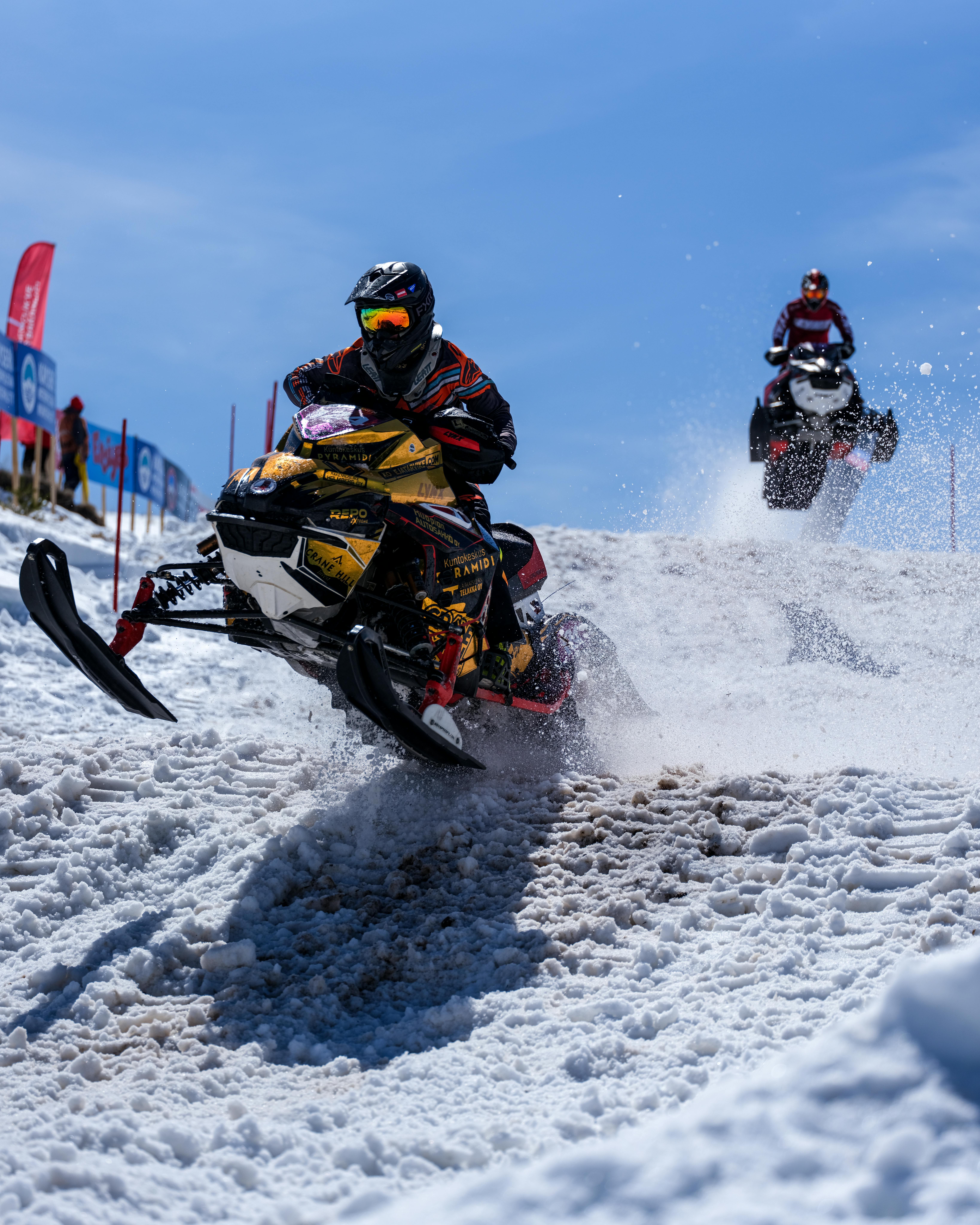 Exciting Snowmobile Race in Winter Landscape · Free Stock Photo