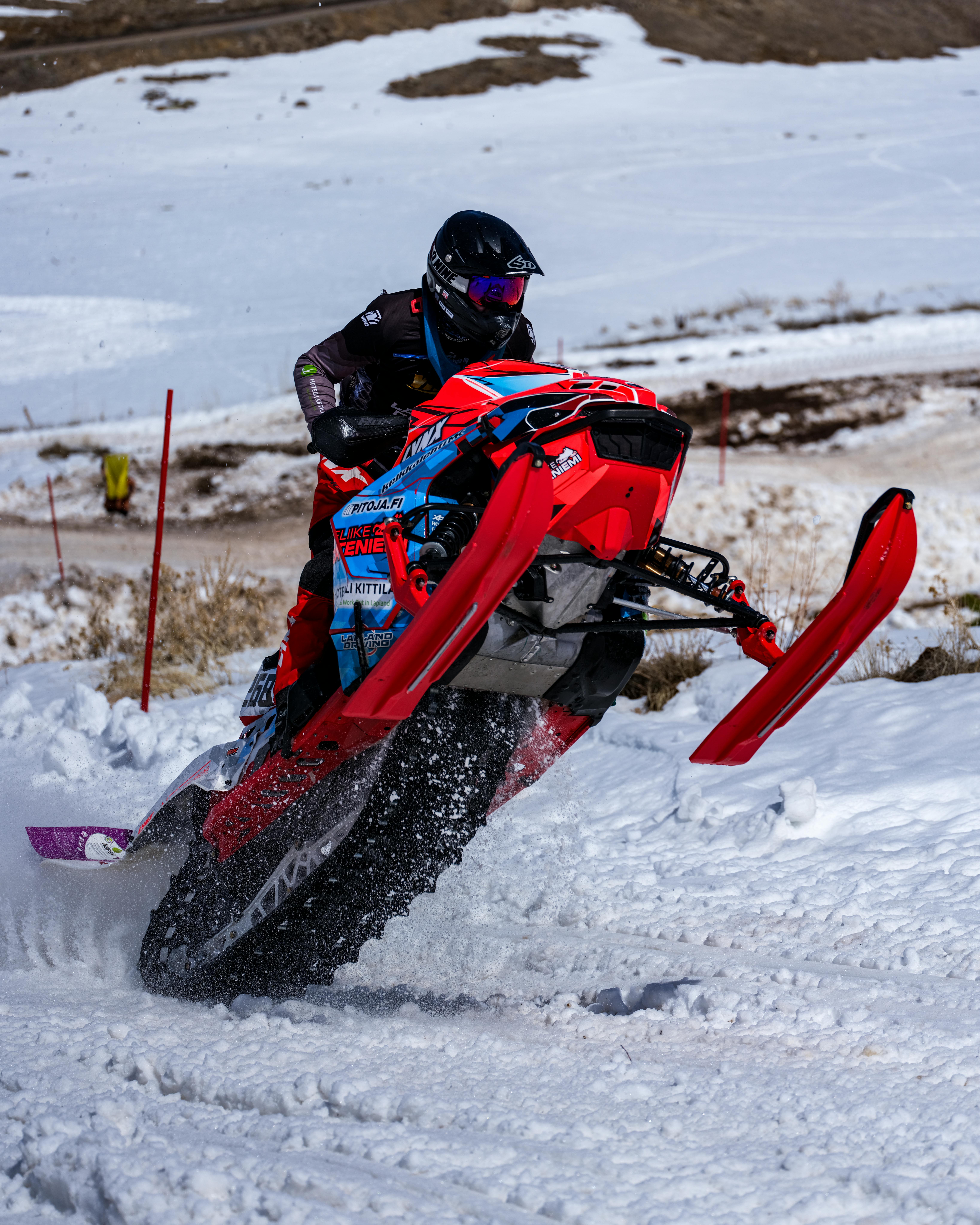 Exciting Snowmobile Race on Winter Terrain · Free Stock Photo