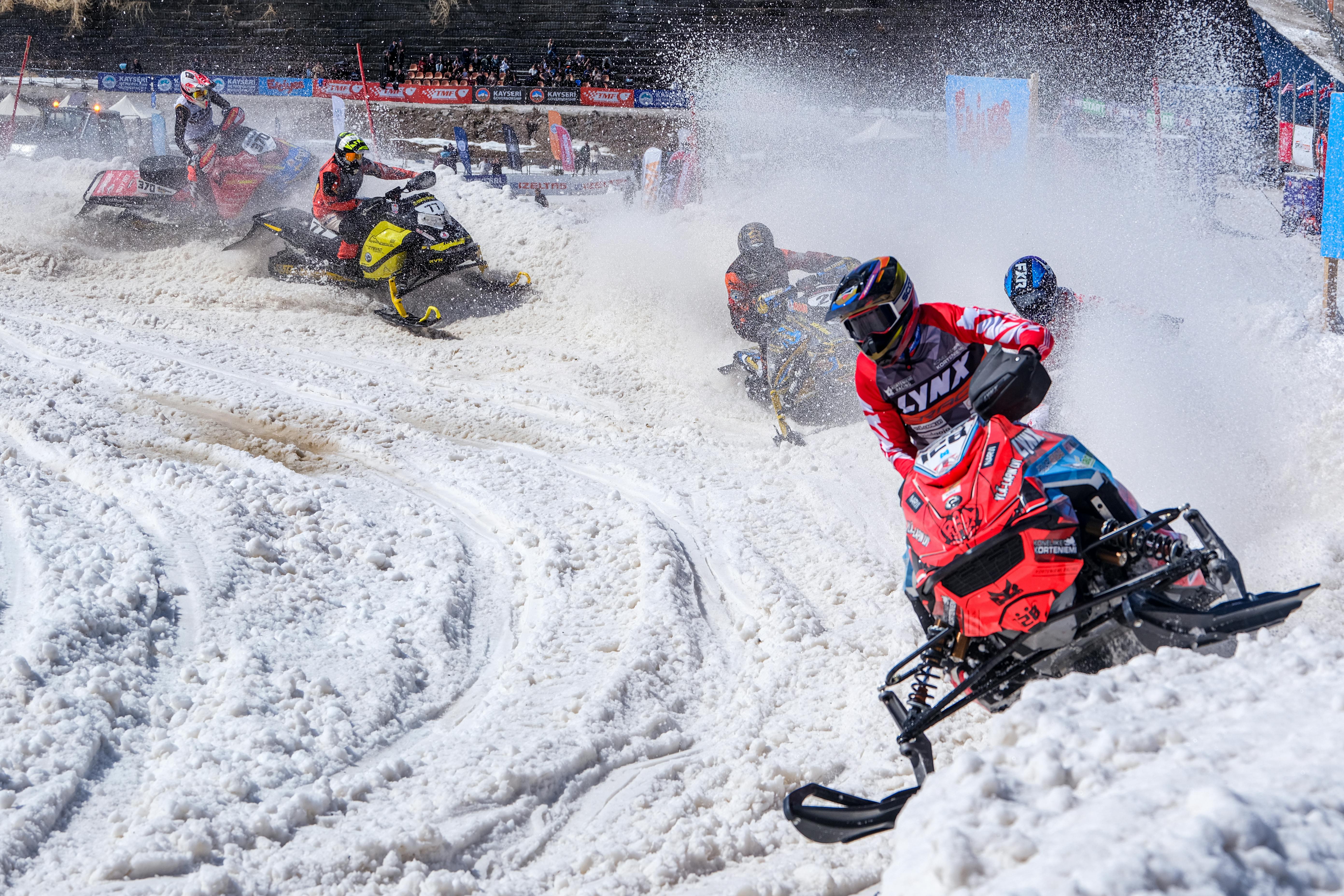Thrilling Snowmobile Race on Snowy Track · Free Stock Photo