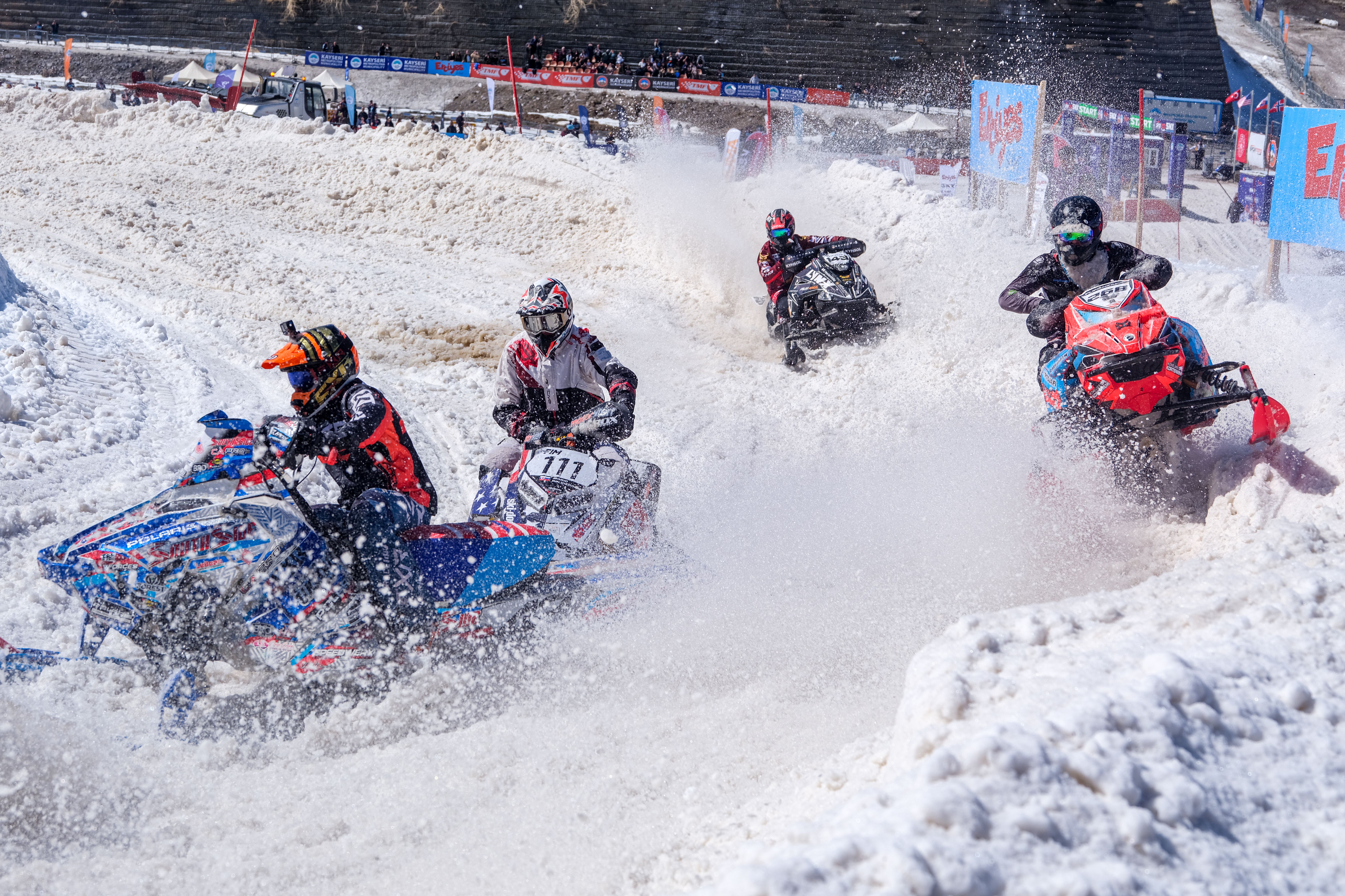 High-speed Snowmobile Race on Icy Track · Free Stock Photo