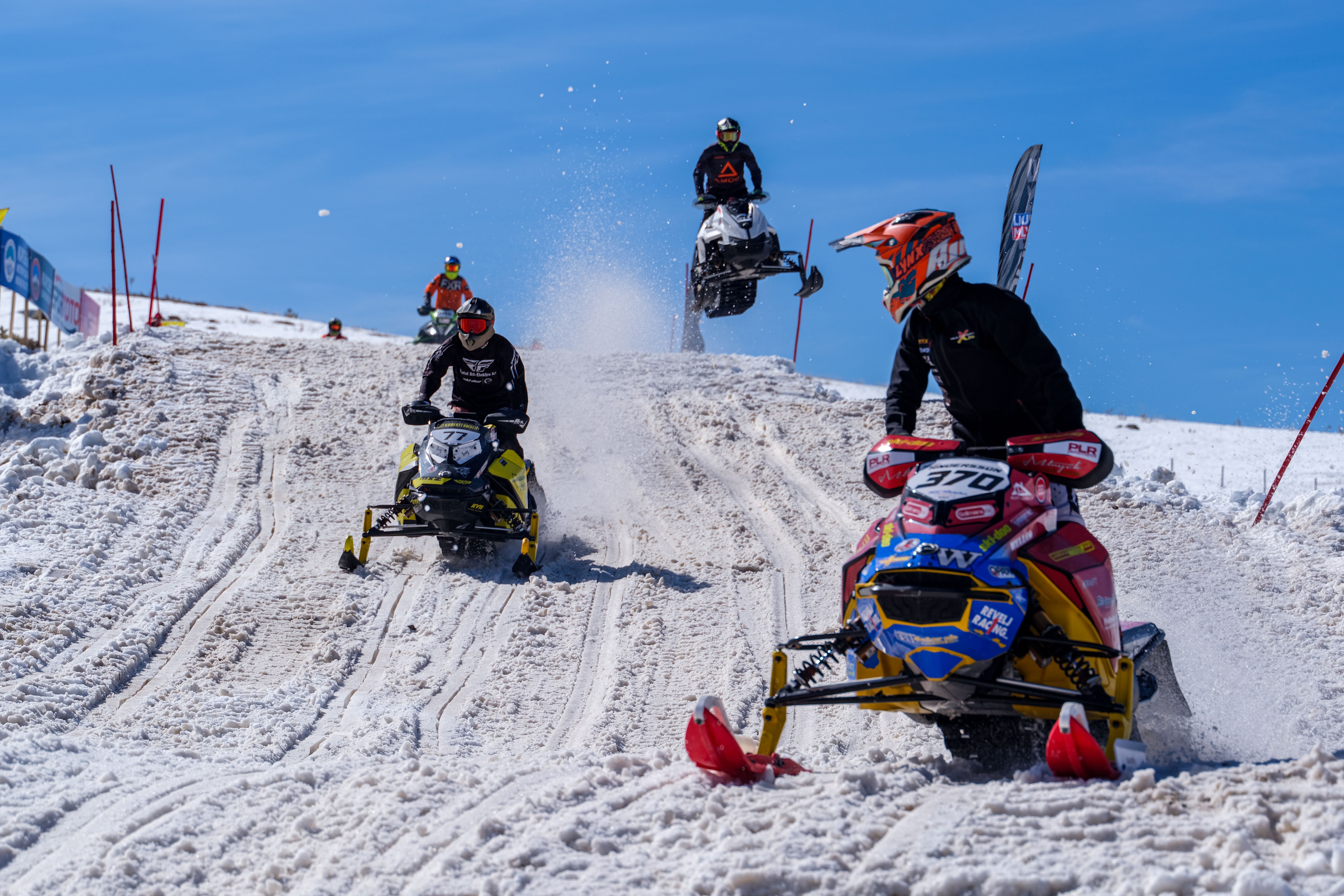 Exciting Snowmobile Race on Snowy Terrain · Free Stock Photo