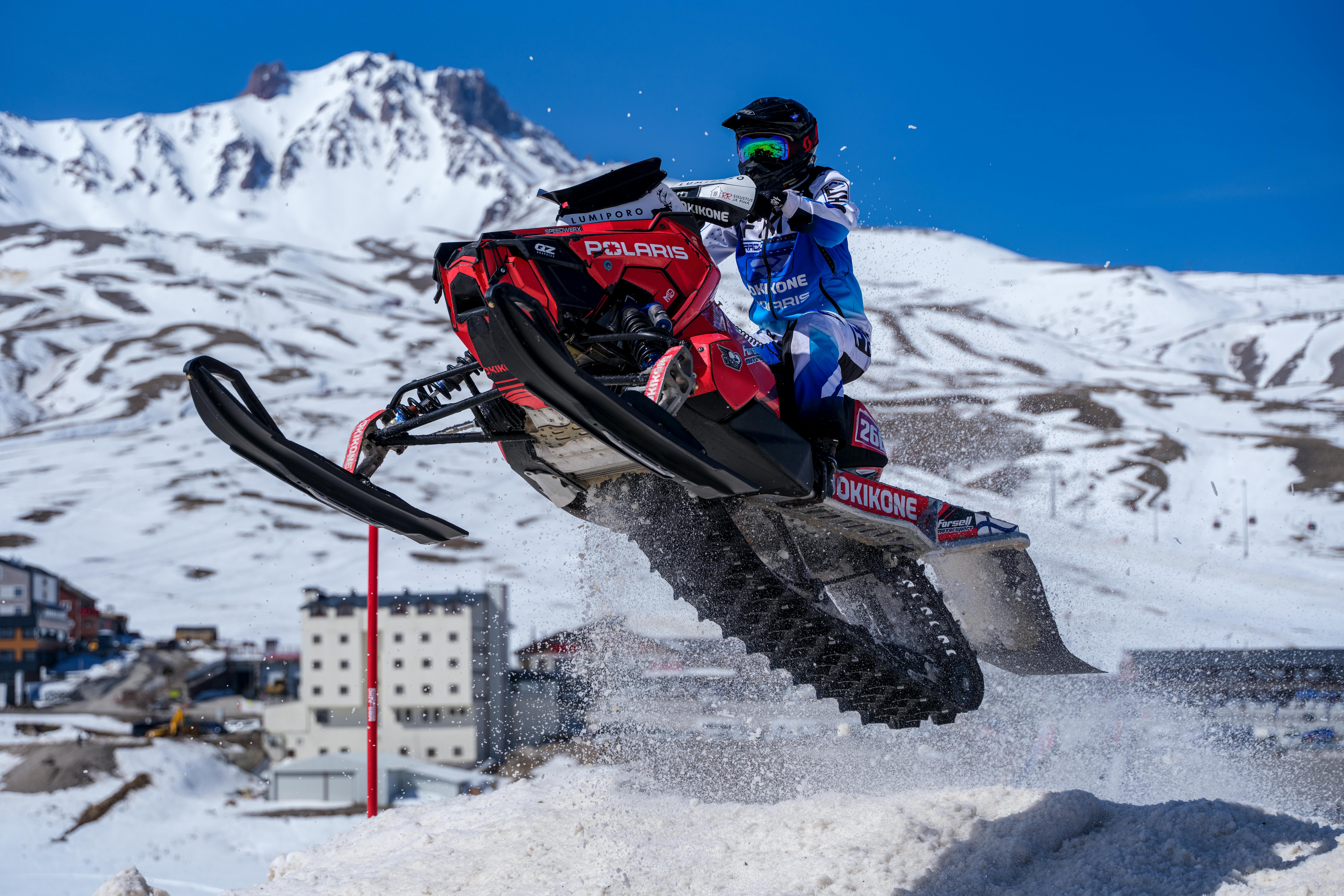 Snowmobile Jumping over Snowy Terrain in Winter · Free Stock Photo