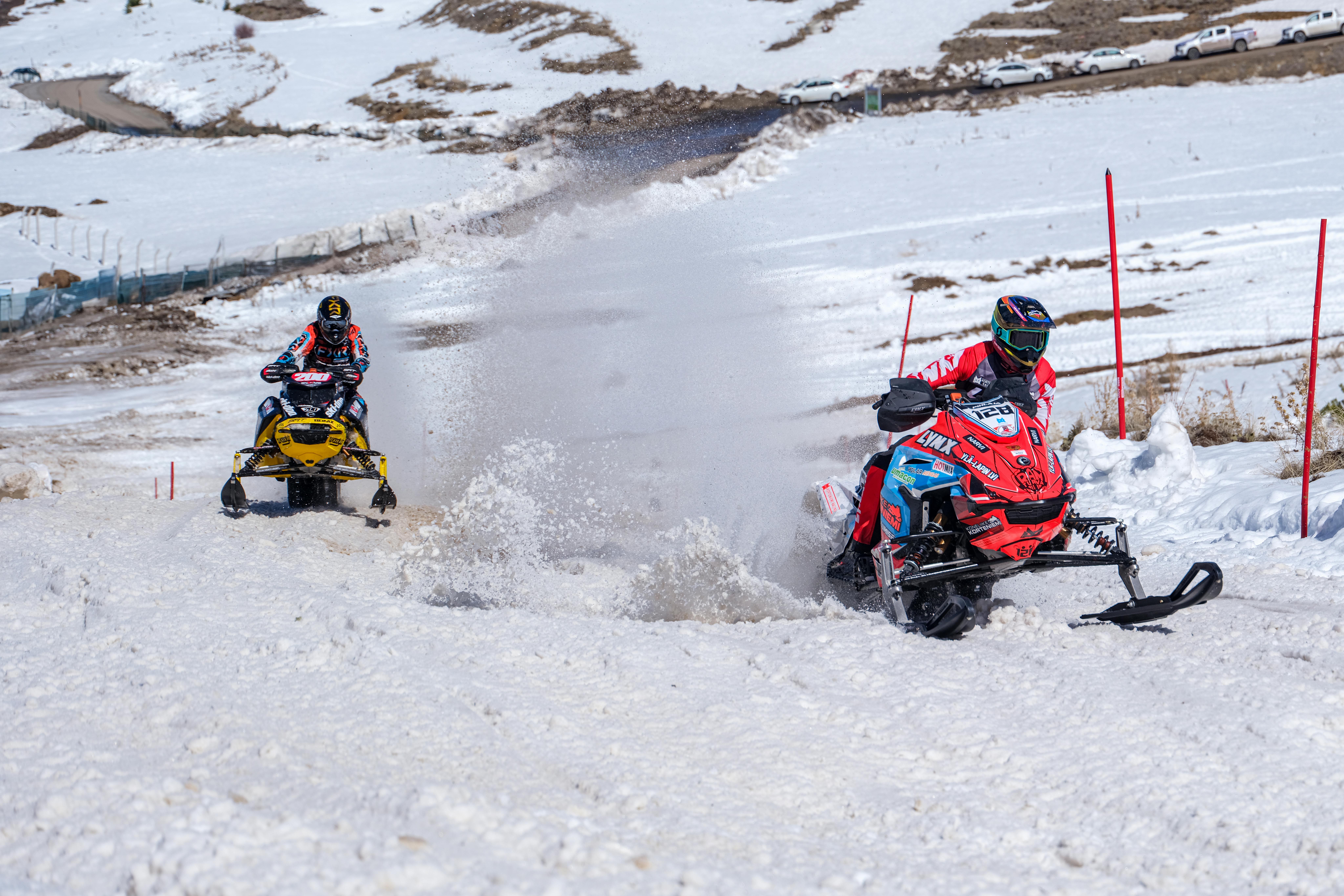 Exciting Snowmobile Race on Snowy Mountain Track · Free Stock Photo