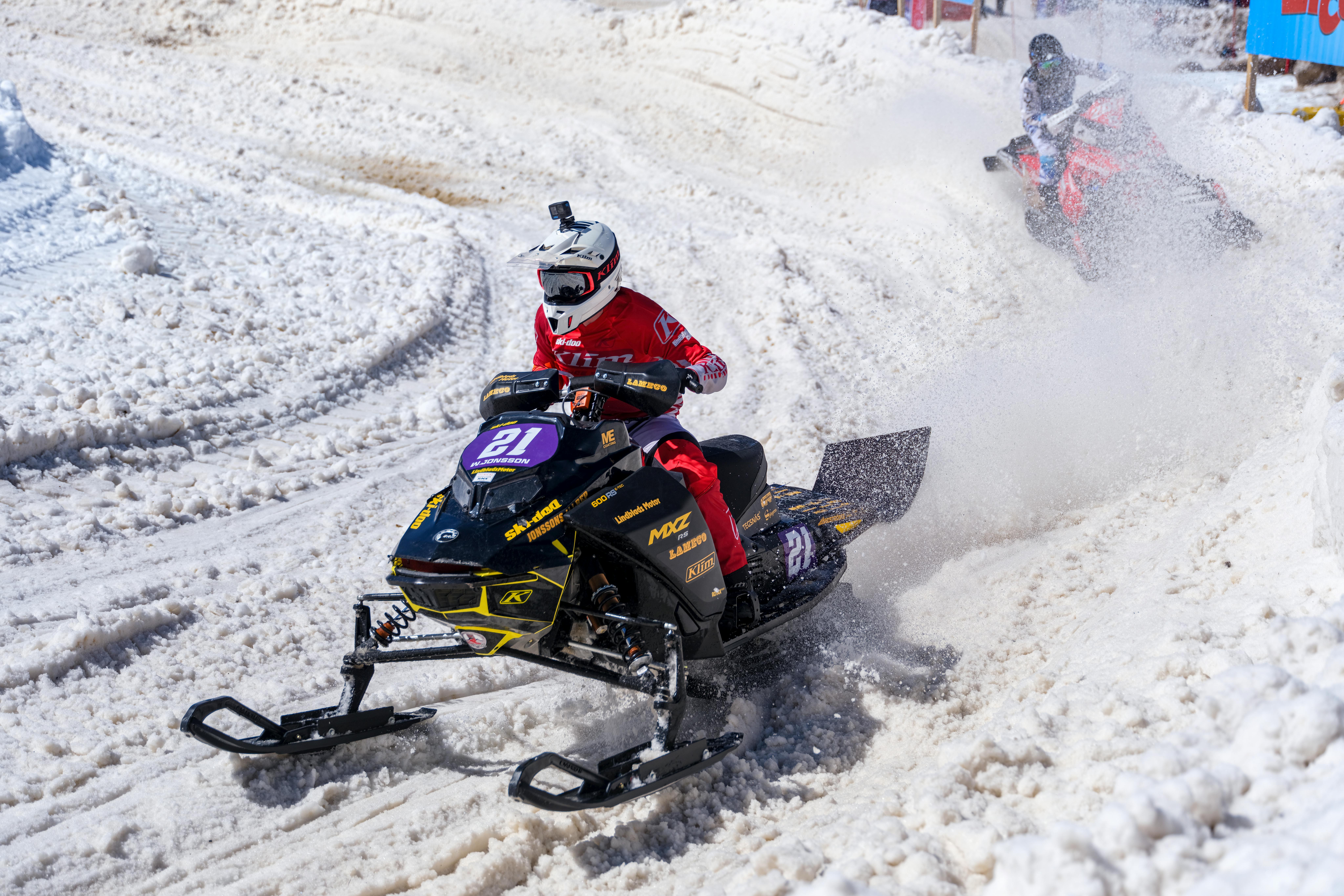 Dynamic Snowmobile Race on Snowy Circuit · Free Stock Photo
