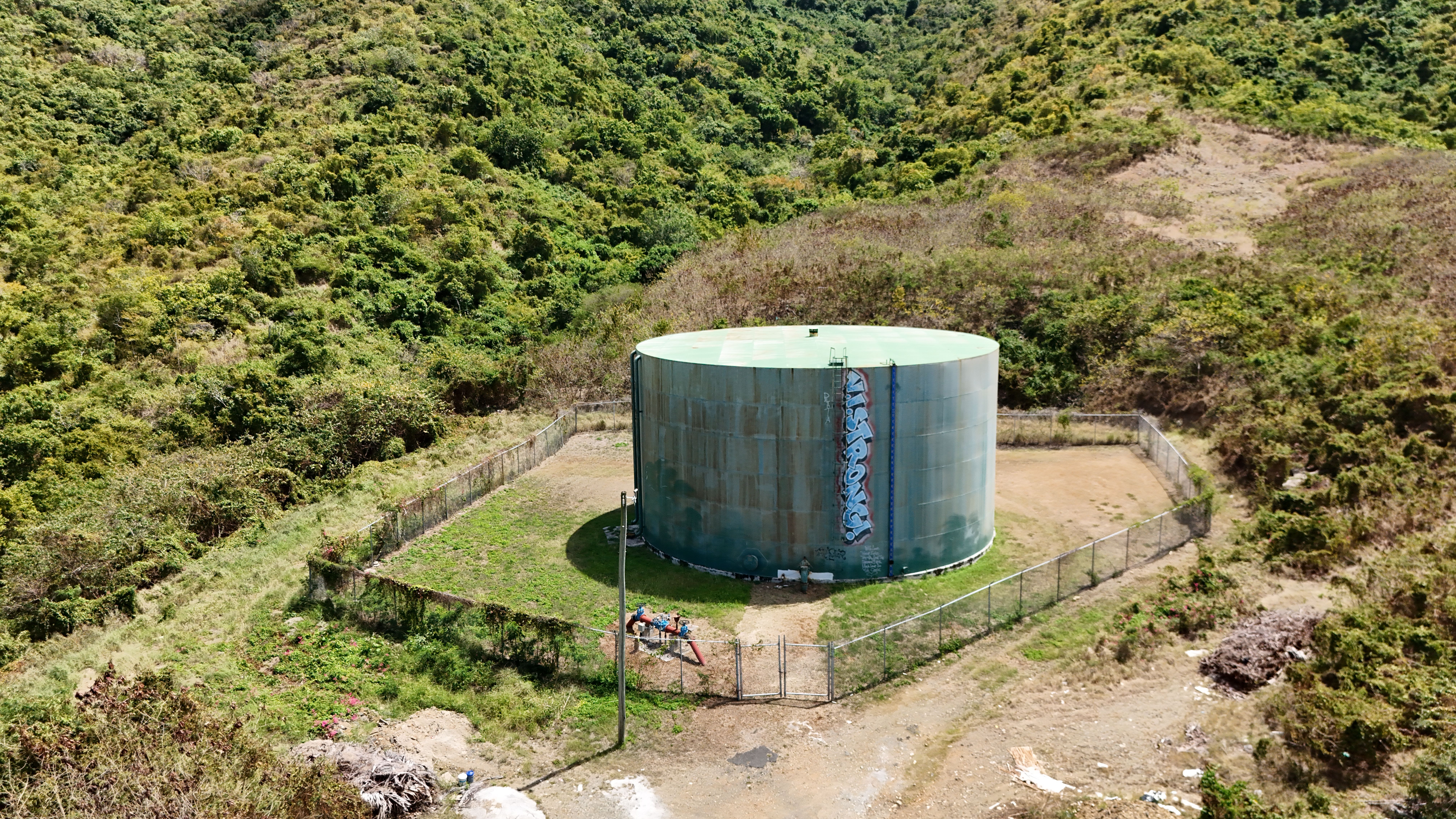 Aerial View of Large Water Tank in Lush Landscape · Free Stock Photo