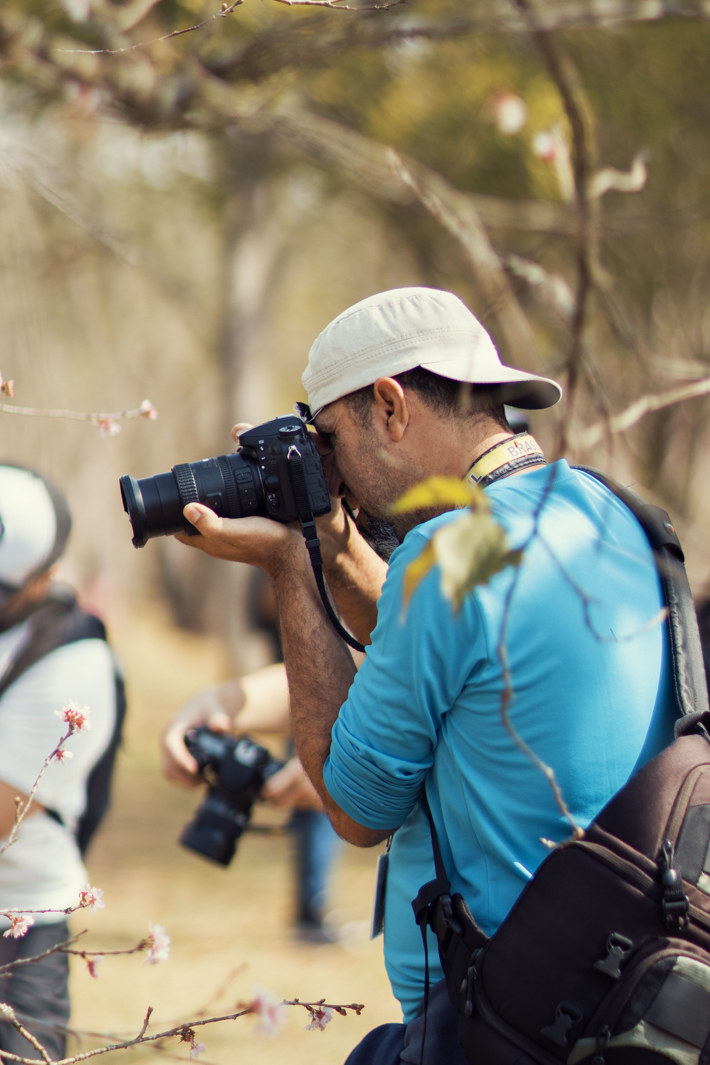 Professional Photographer Capturing Outdoors · Free Stock Photo