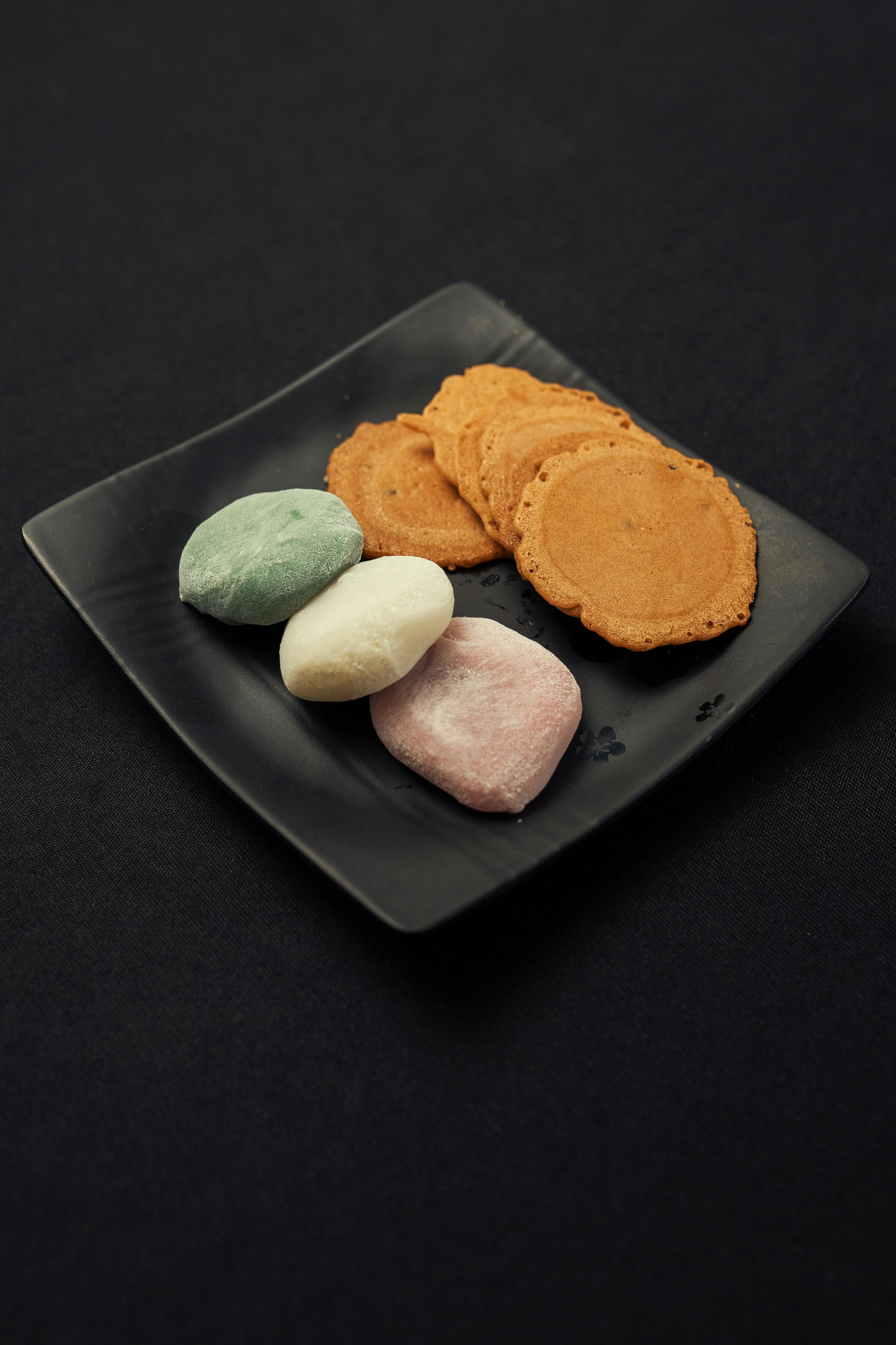 Assorted Mochi and Cookies on Black Plate · Free Stock Photo
