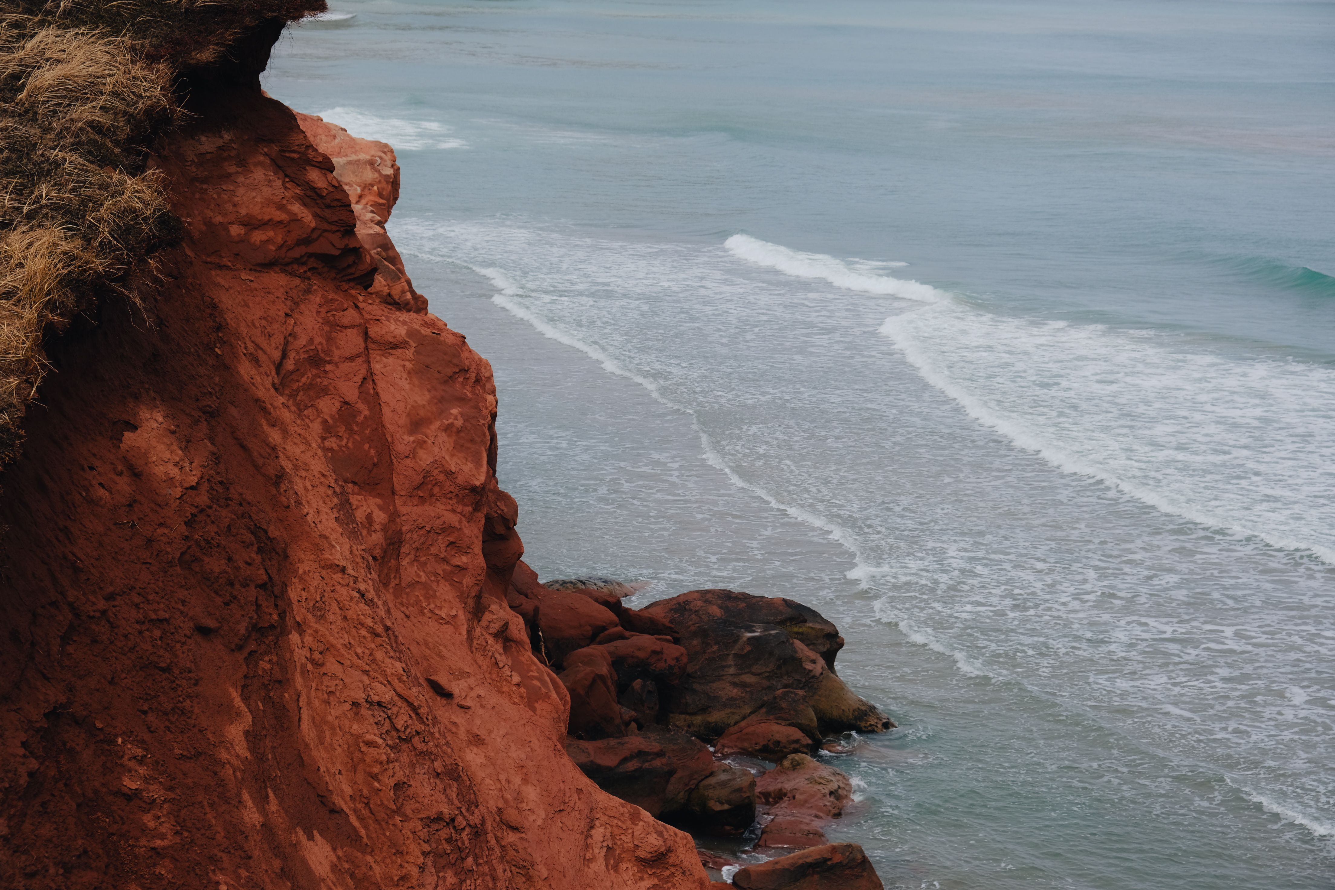 Scenic Red Cliffs by the Ocean at Daytime · Free Stock Photo