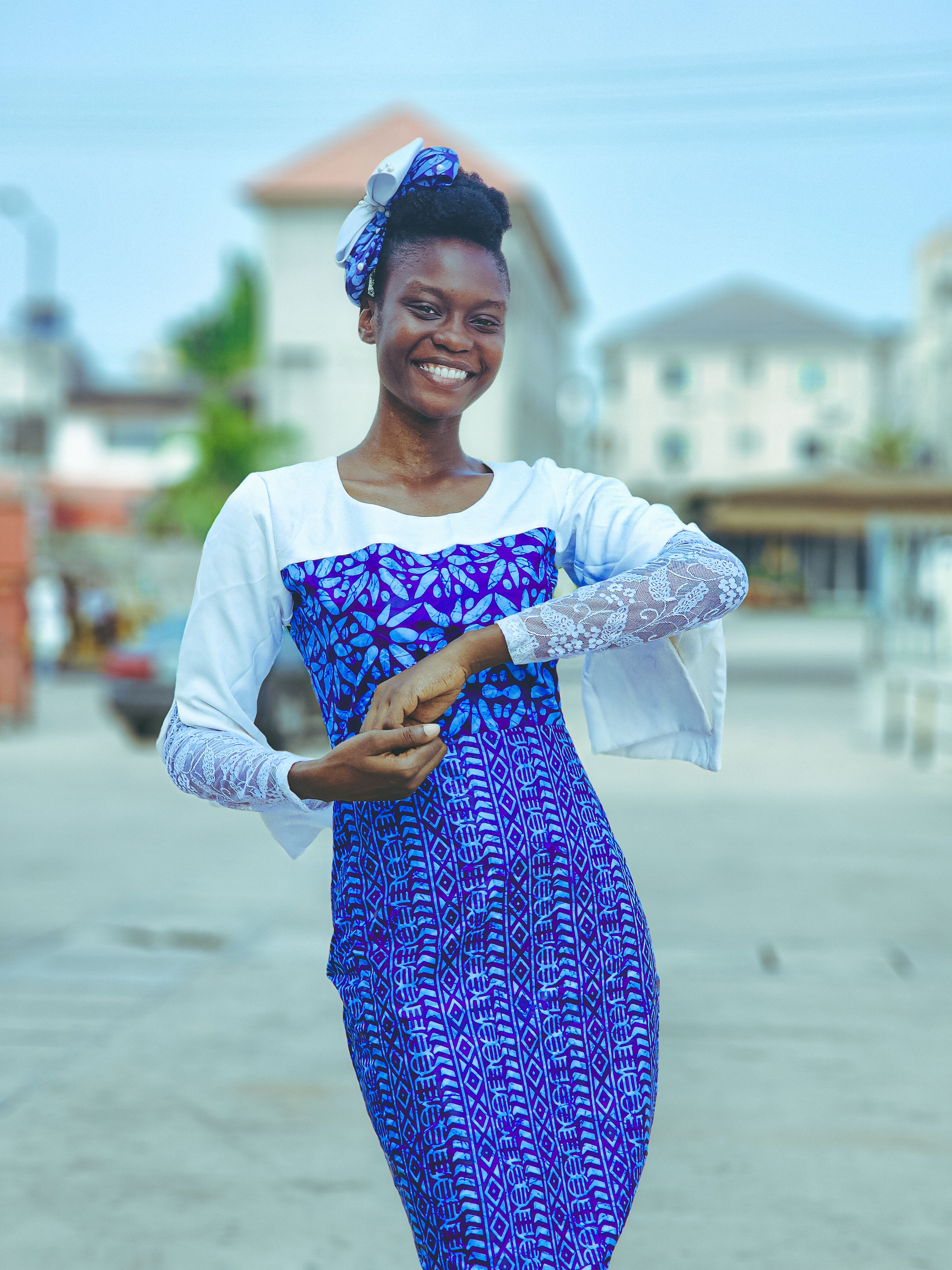 Smiling Woman in Blue Traditional Dress Outdoors · Free Stock Photo