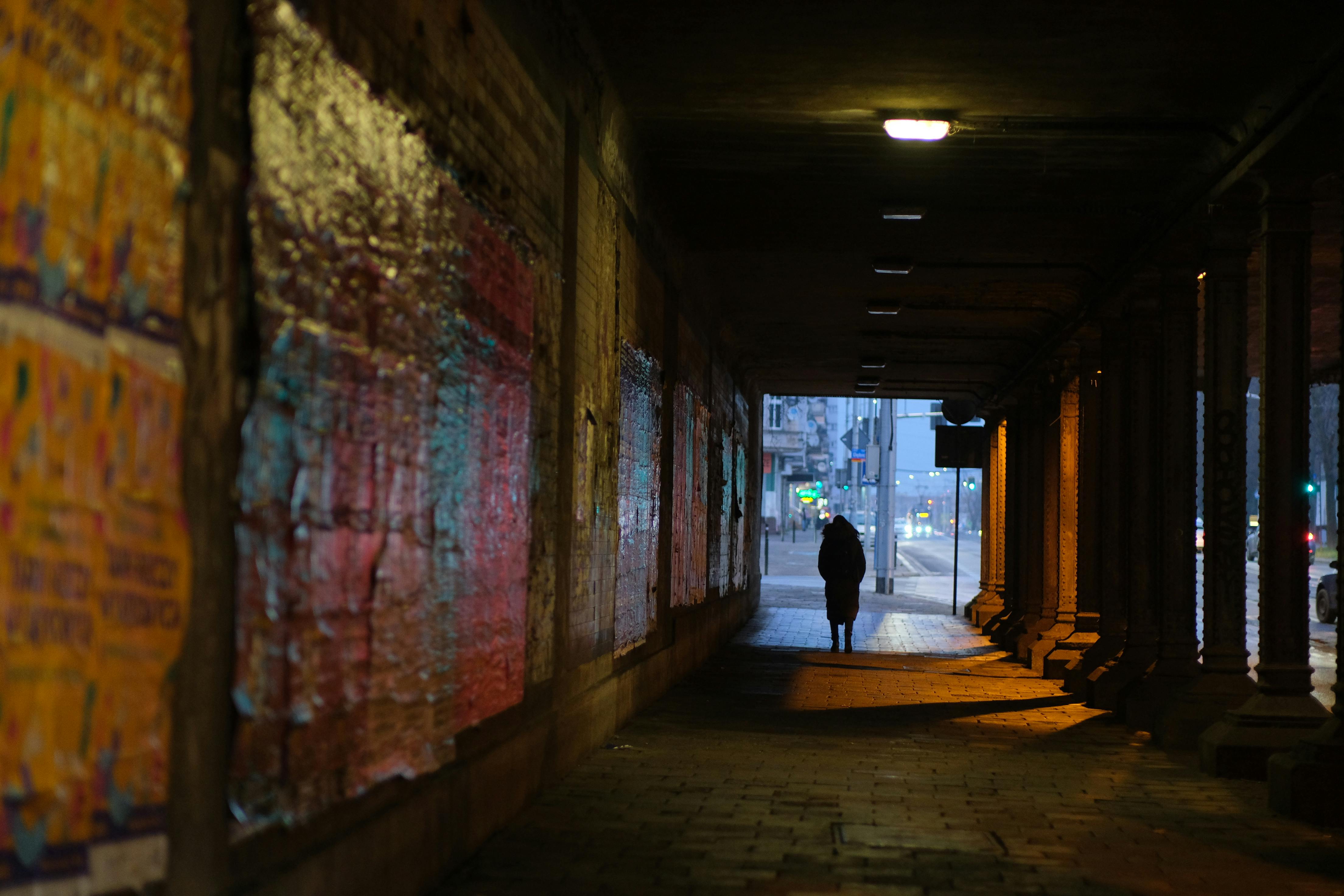 Silhouette of Person Walking in Urban Underpass at Night · Free Stock Photo