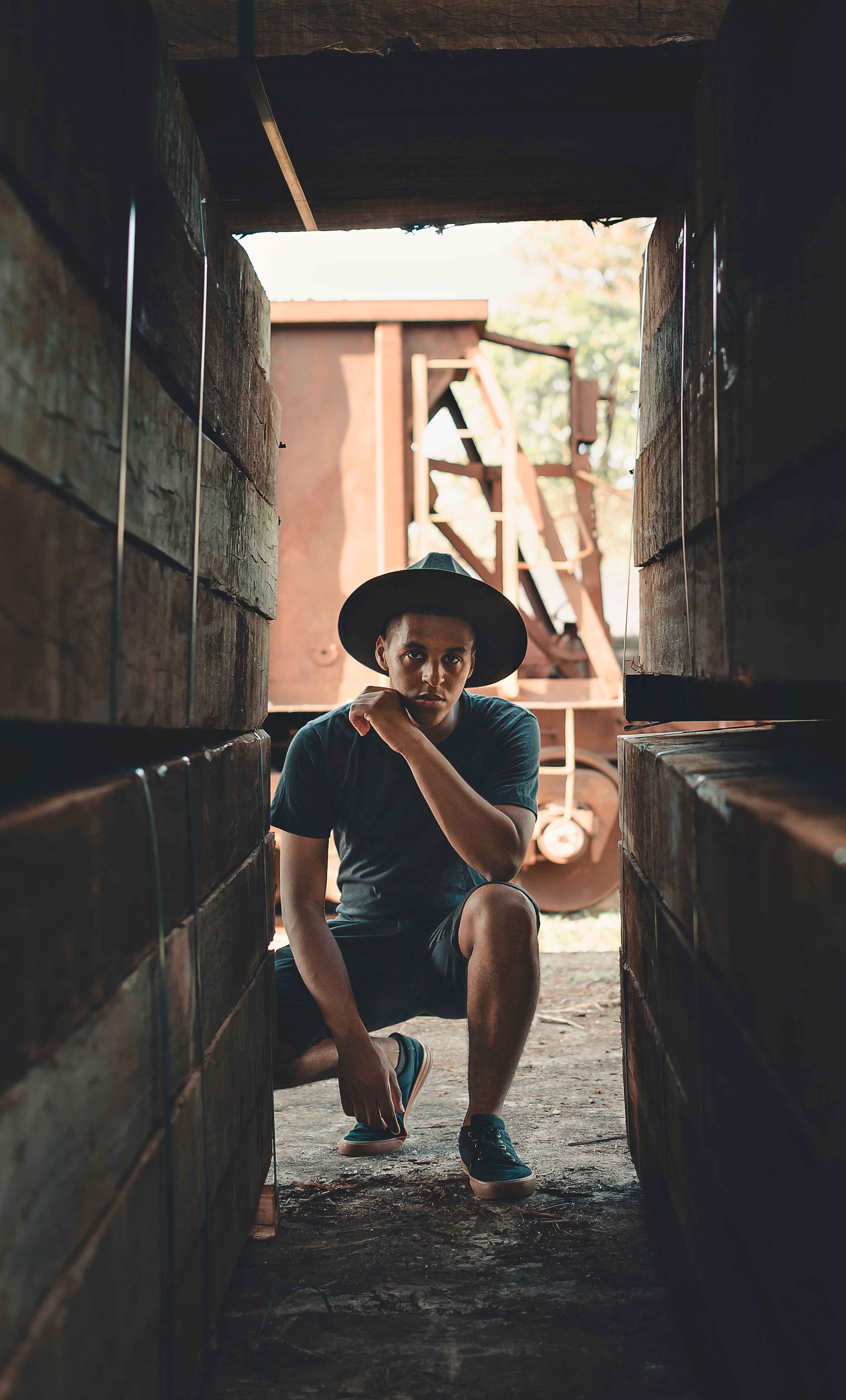 Man Sitting Wearing a Hat · Free Stock Photo