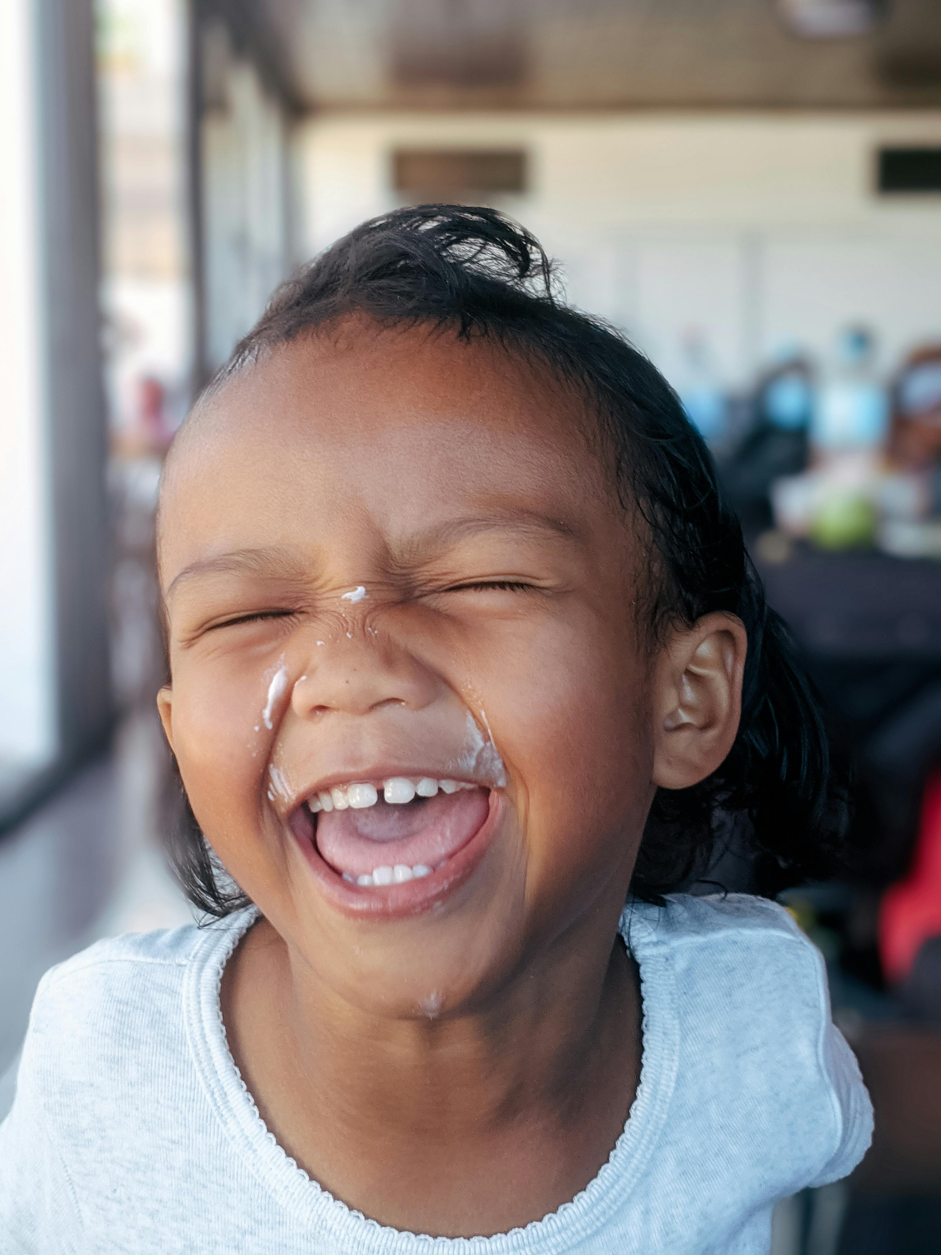 Joyful Child with Ice Cream Smudges Smiling · Free Stock Photo