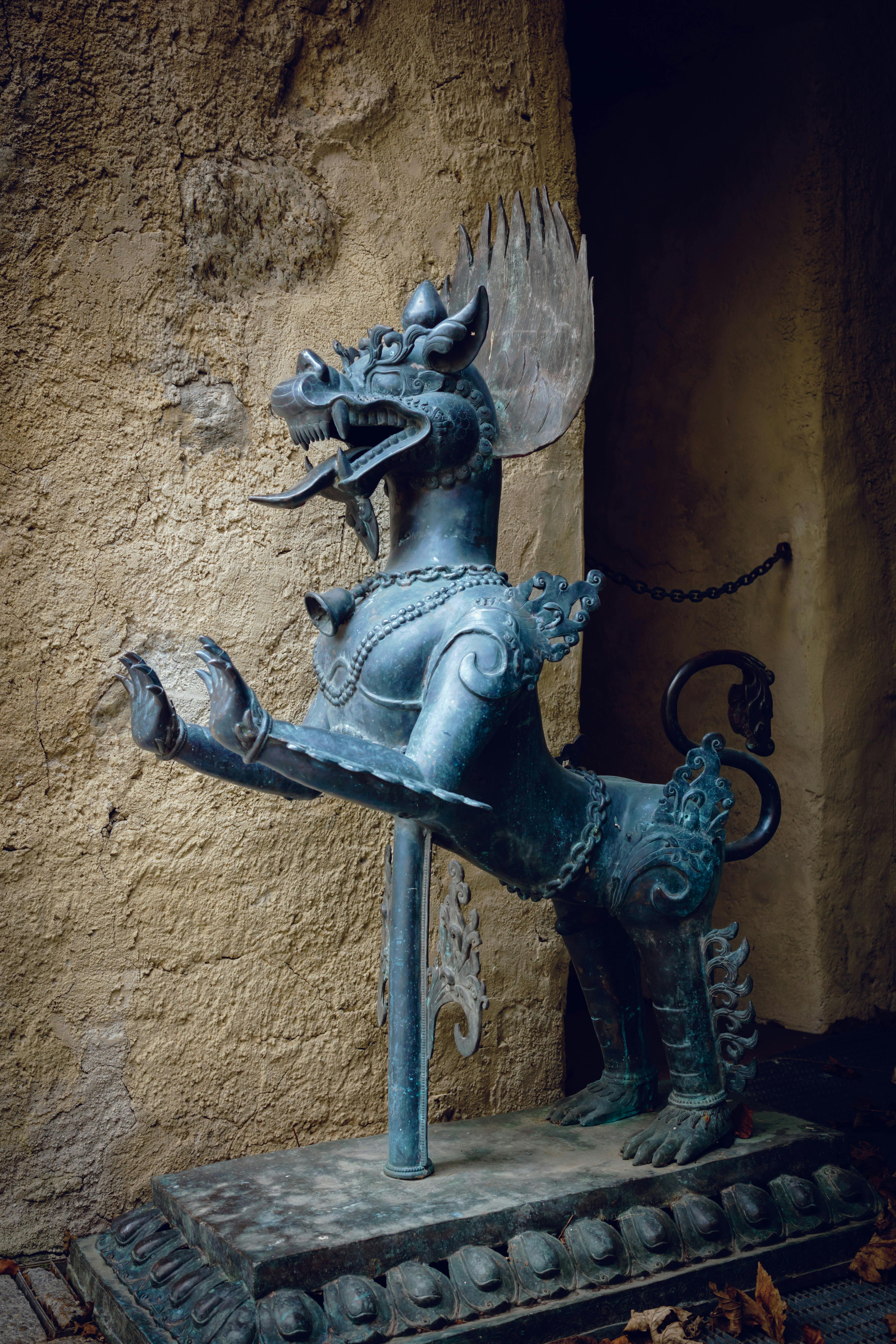 Bronze Kirin Statue in Rustic Outdoor Setting · Free Stock Photo