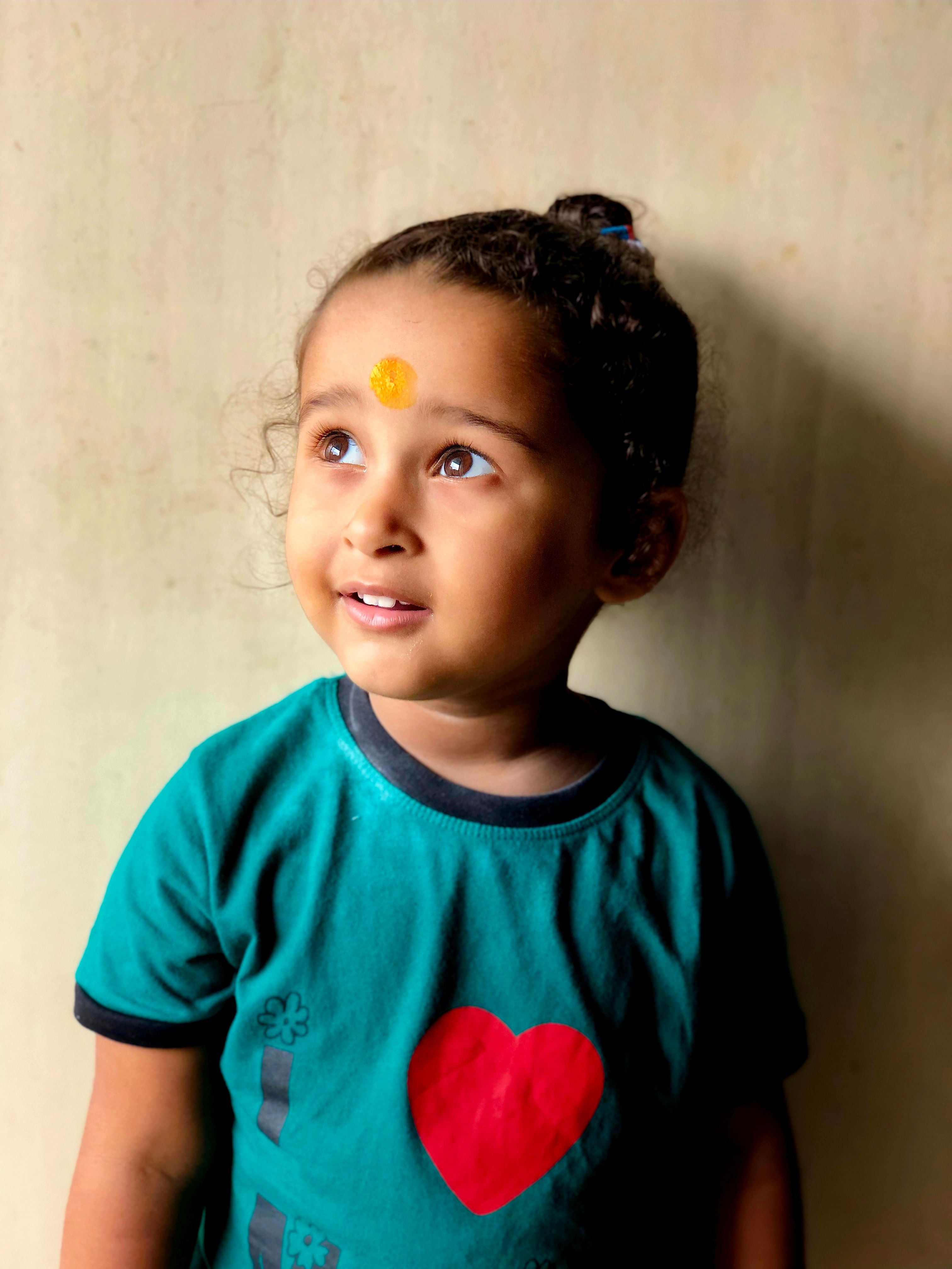 Smiling Child with Heart Shirt and Mark on Forehead · Free Stock Photo