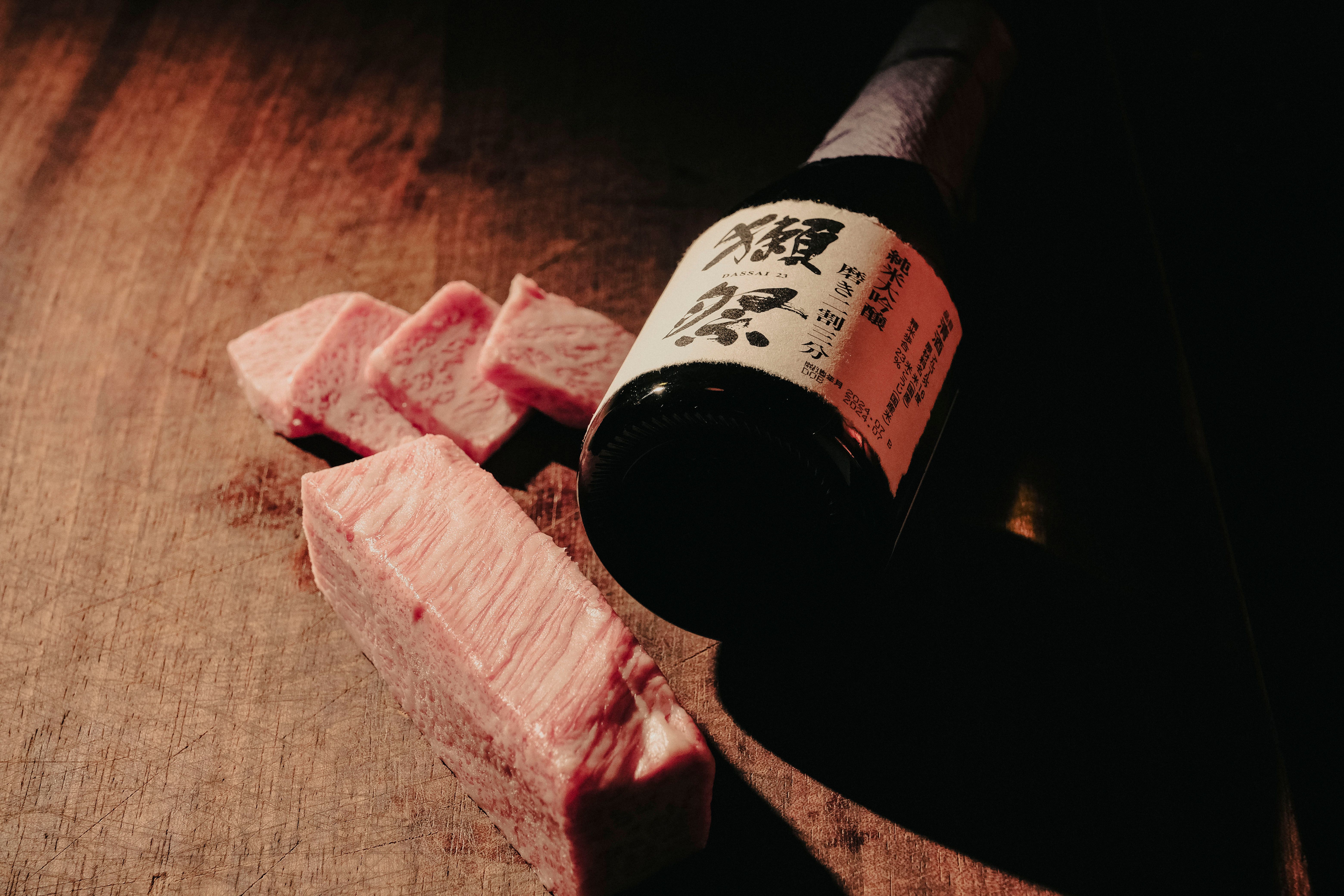 Luxurious Wagyu Beef with Japanese Sake on Wooden Table · Free Stock Photo