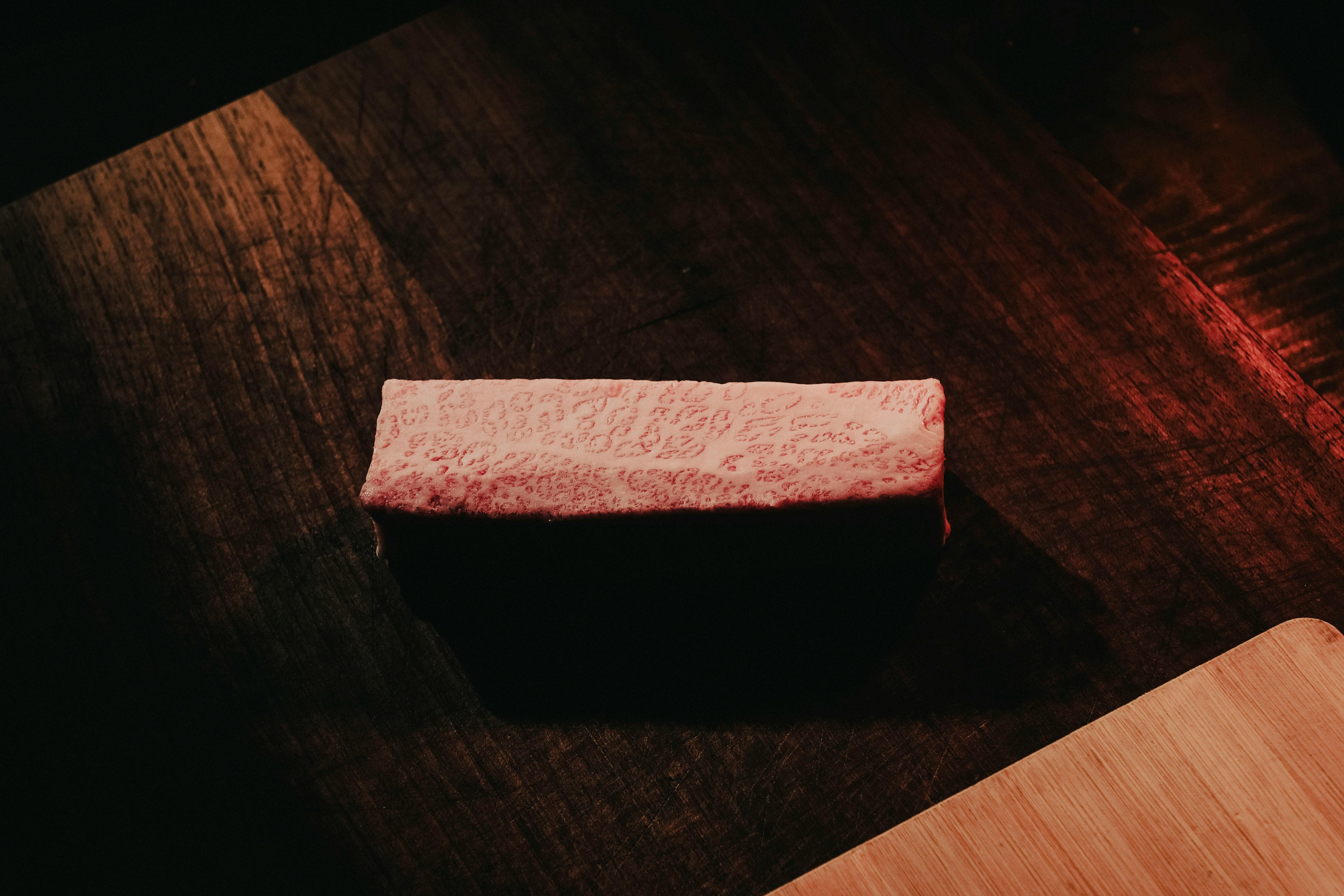 Marbled Wagyu Beef on Rustic Wooden Table · Free Stock Photo