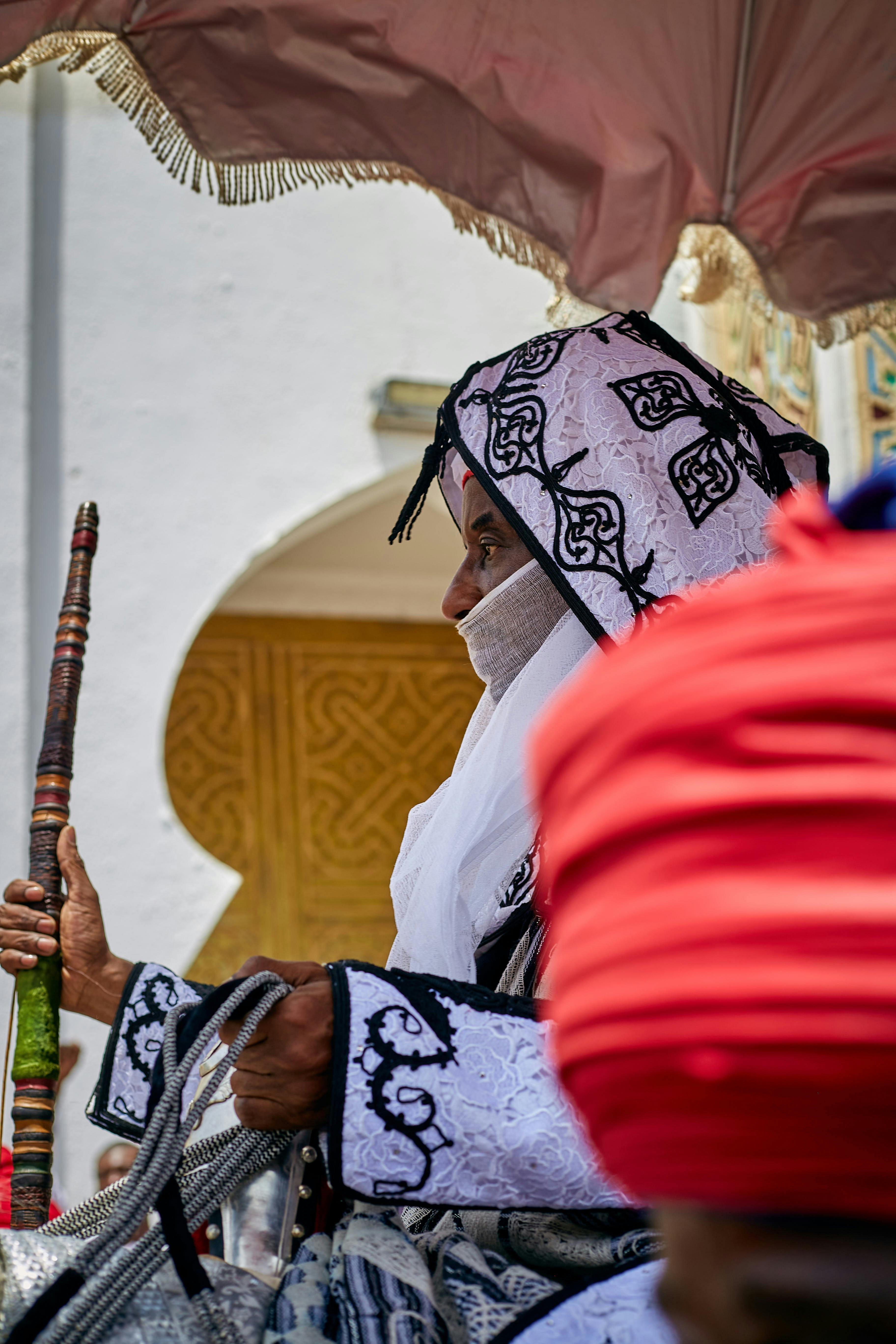 Traditionally Dressed Rider Holding a Decorative Staff · Free Stock Photo