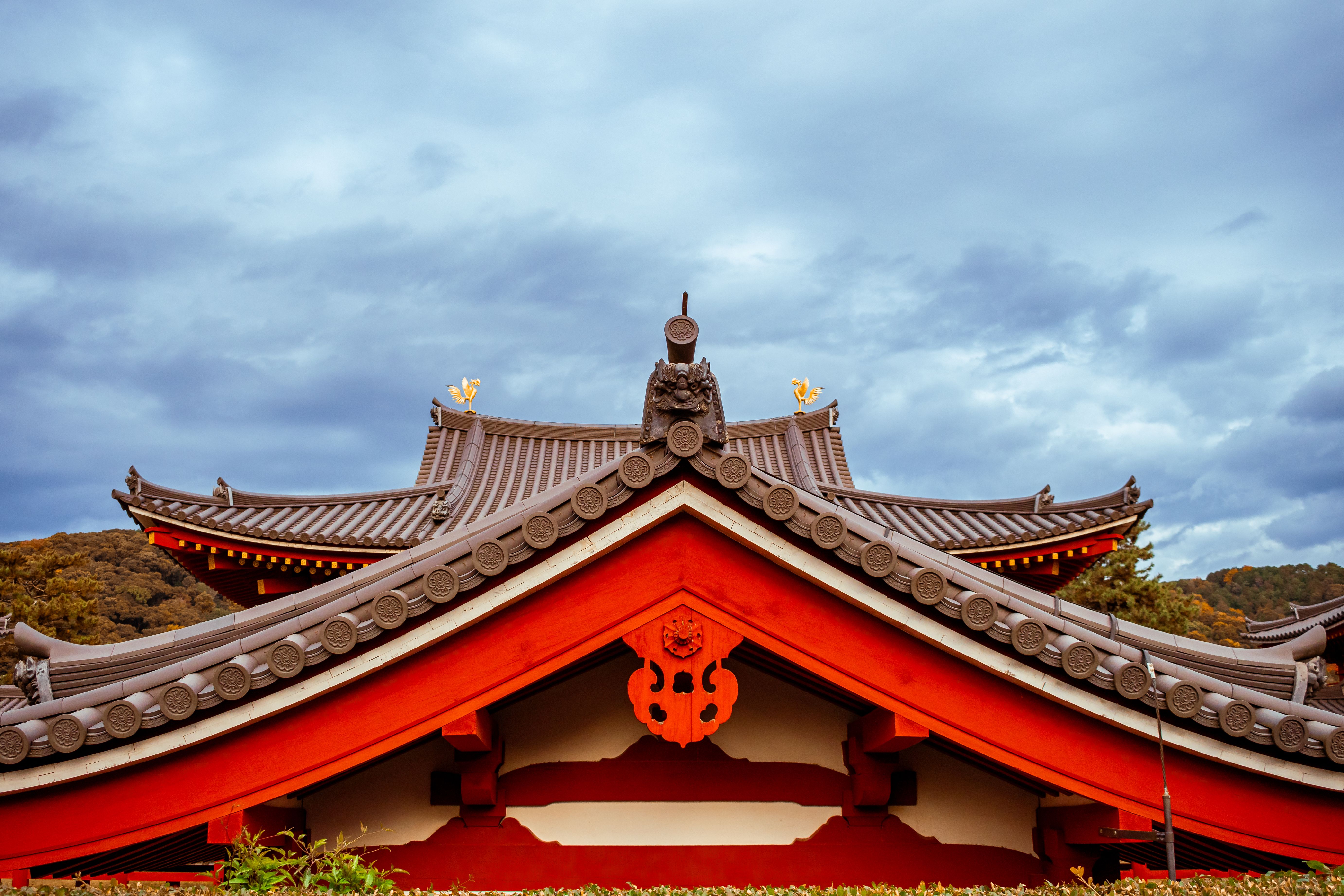 Traditional Japanese Temple Roof Against Cloudy Sky · Free Stock Photo