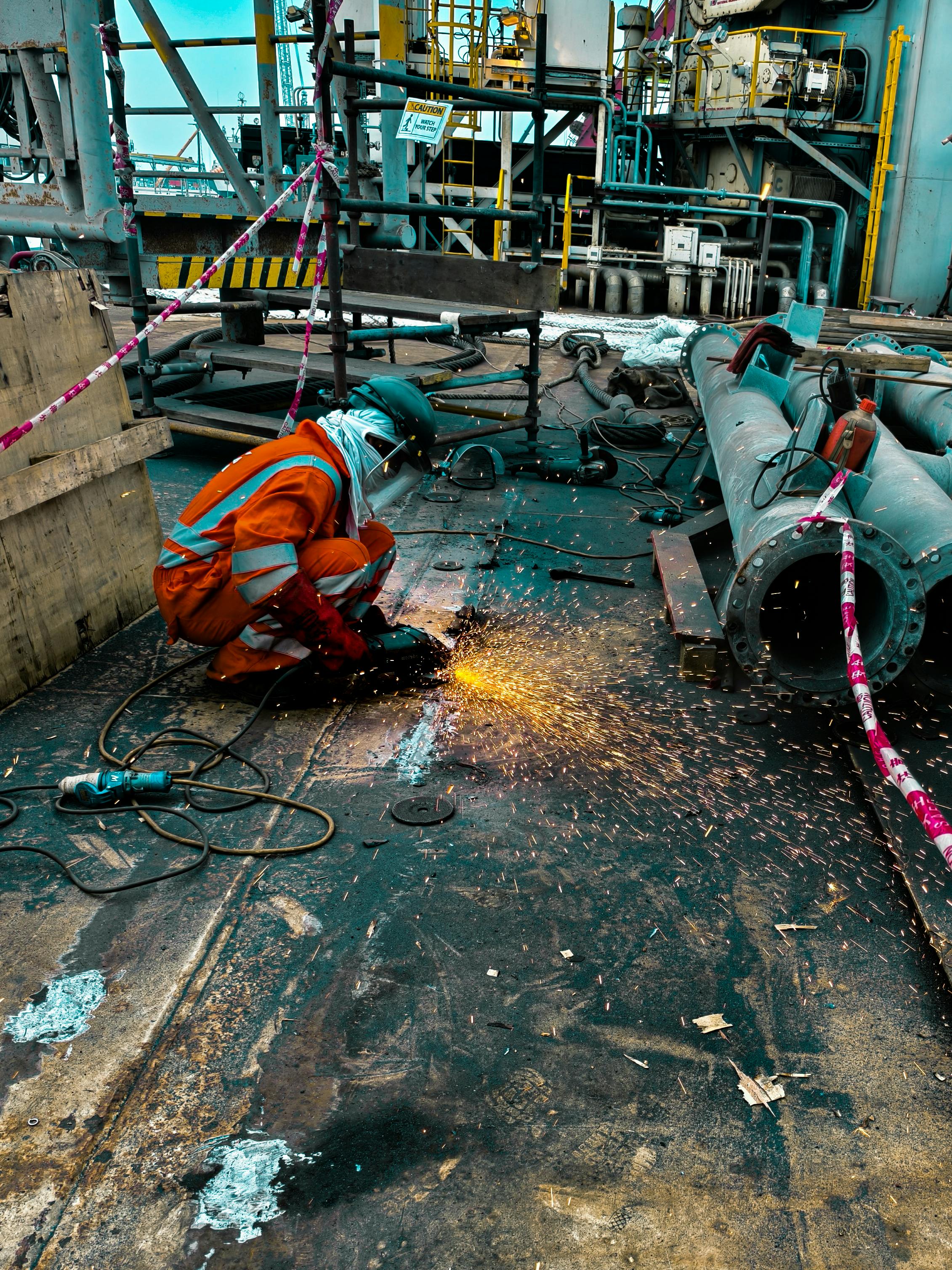 Industrial Worker Welding on Offshore Rig · Free Stock Photo