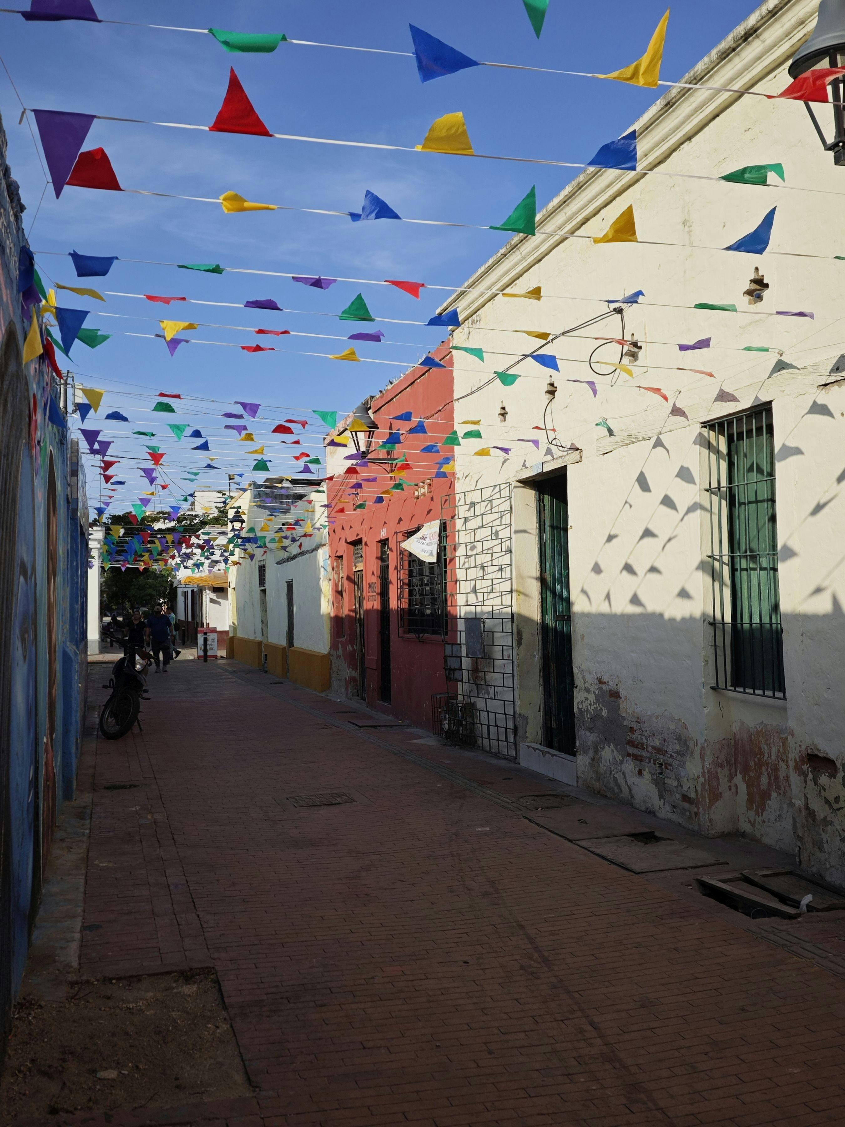Colorful Festival Flags in Quaint Alleyway · Free Stock Photo