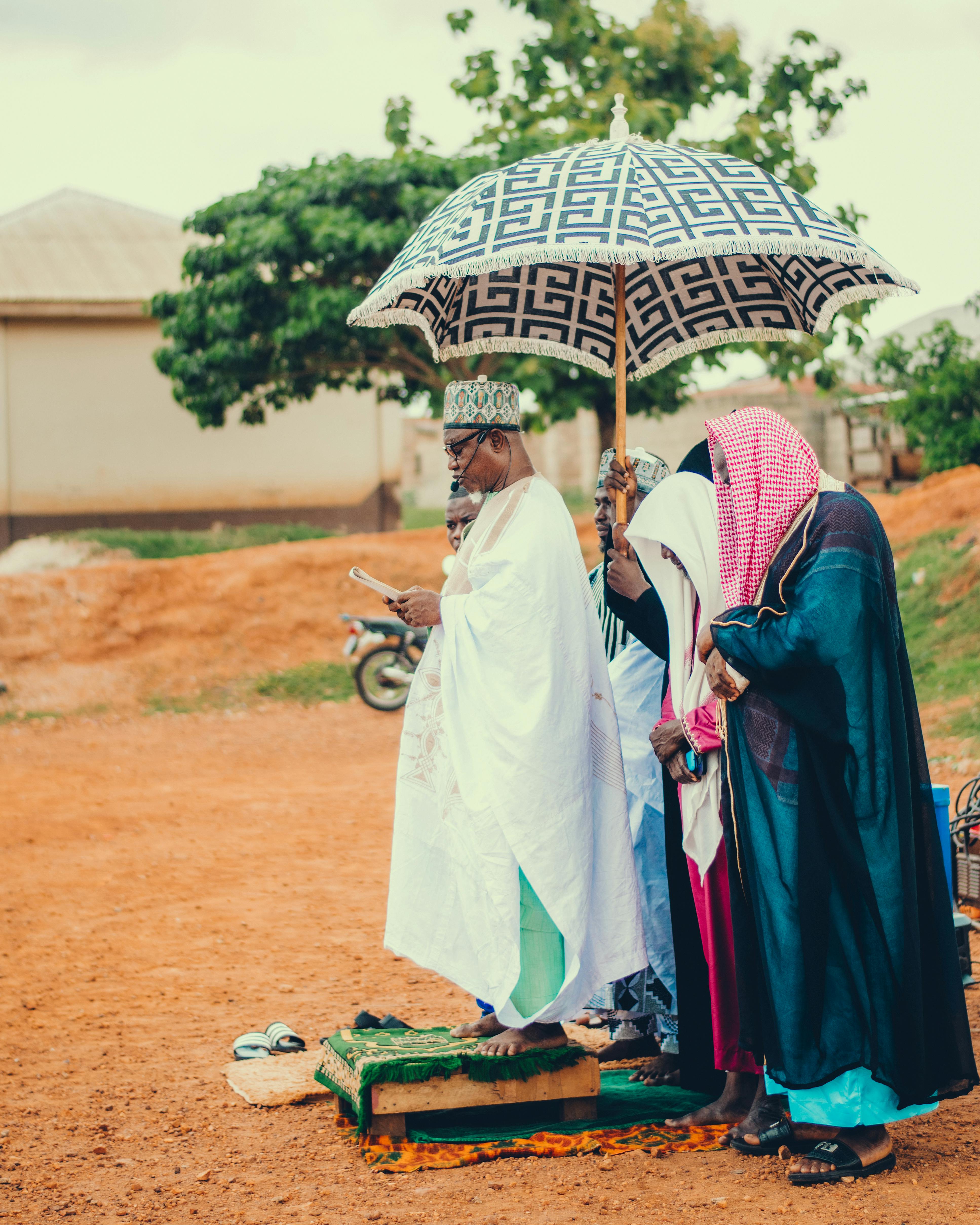 Muslim Prayer Gathering Under Umbrella · Free Stock Photo