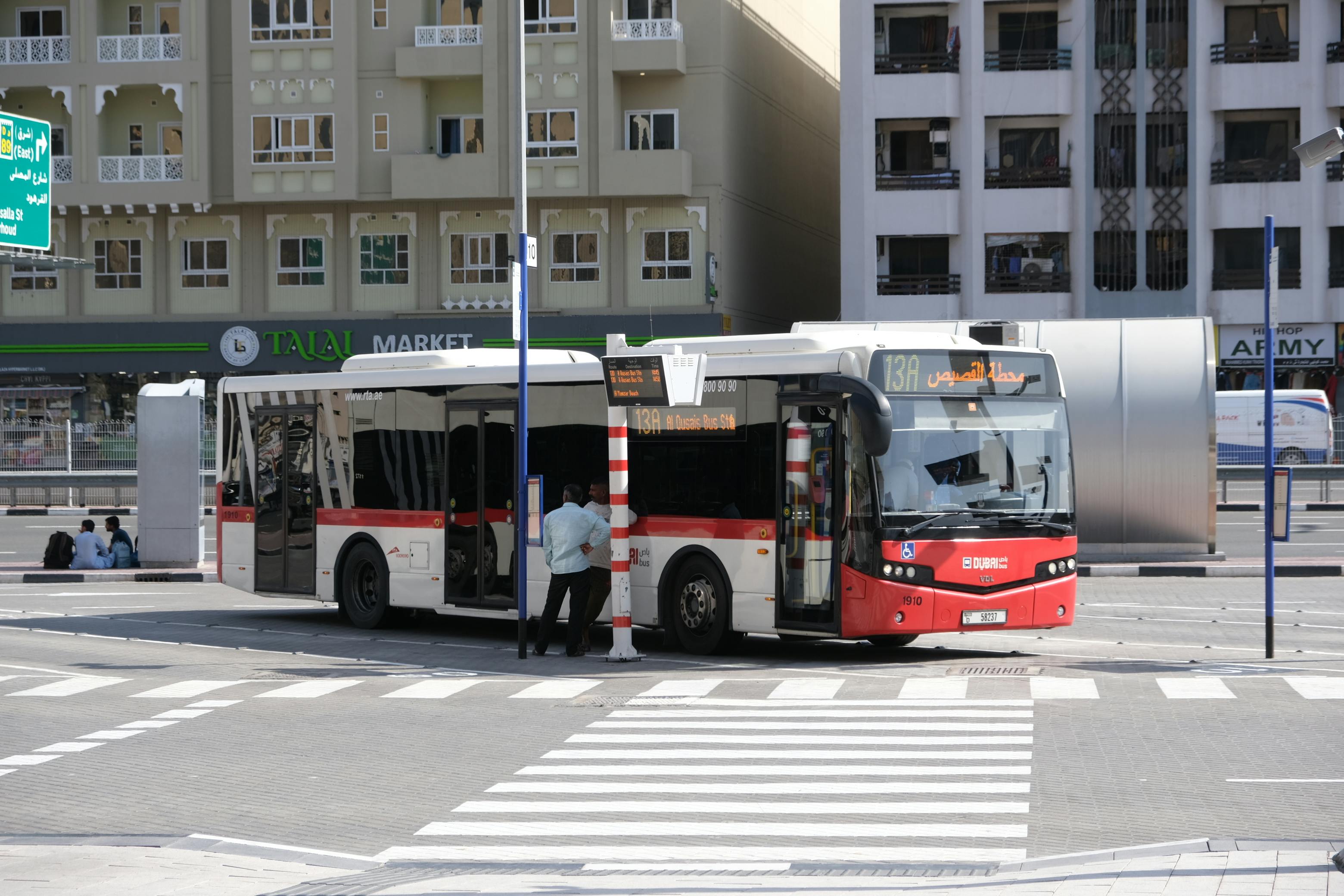 Dubai Public Bus at a City Street Stop · Free Stock Photo