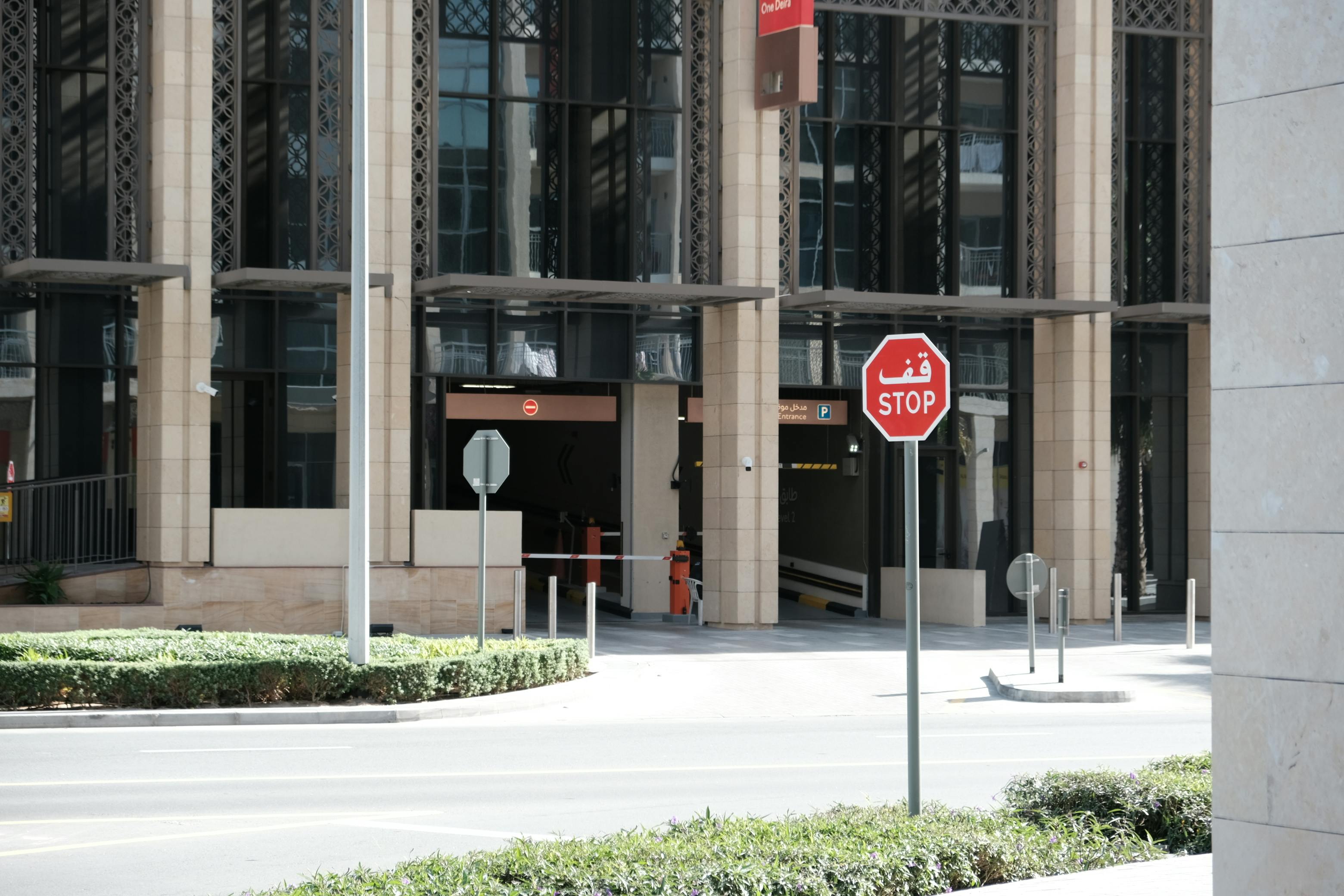 Modern Architecture with Multilingual Stop Sign in Dubai · Free Stock Photo