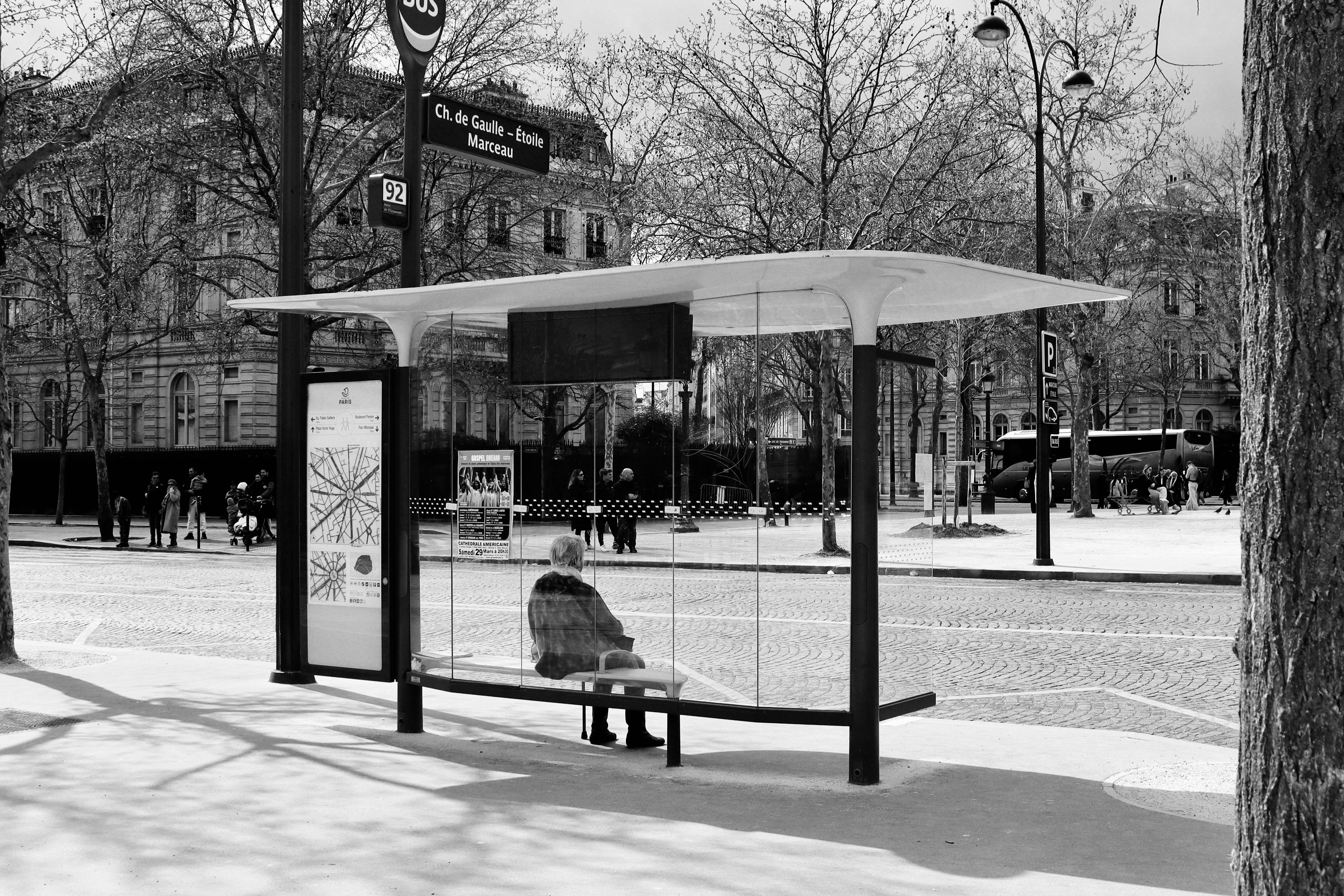 Black and White Paris Bus Stop Scene · Free Stock Photo