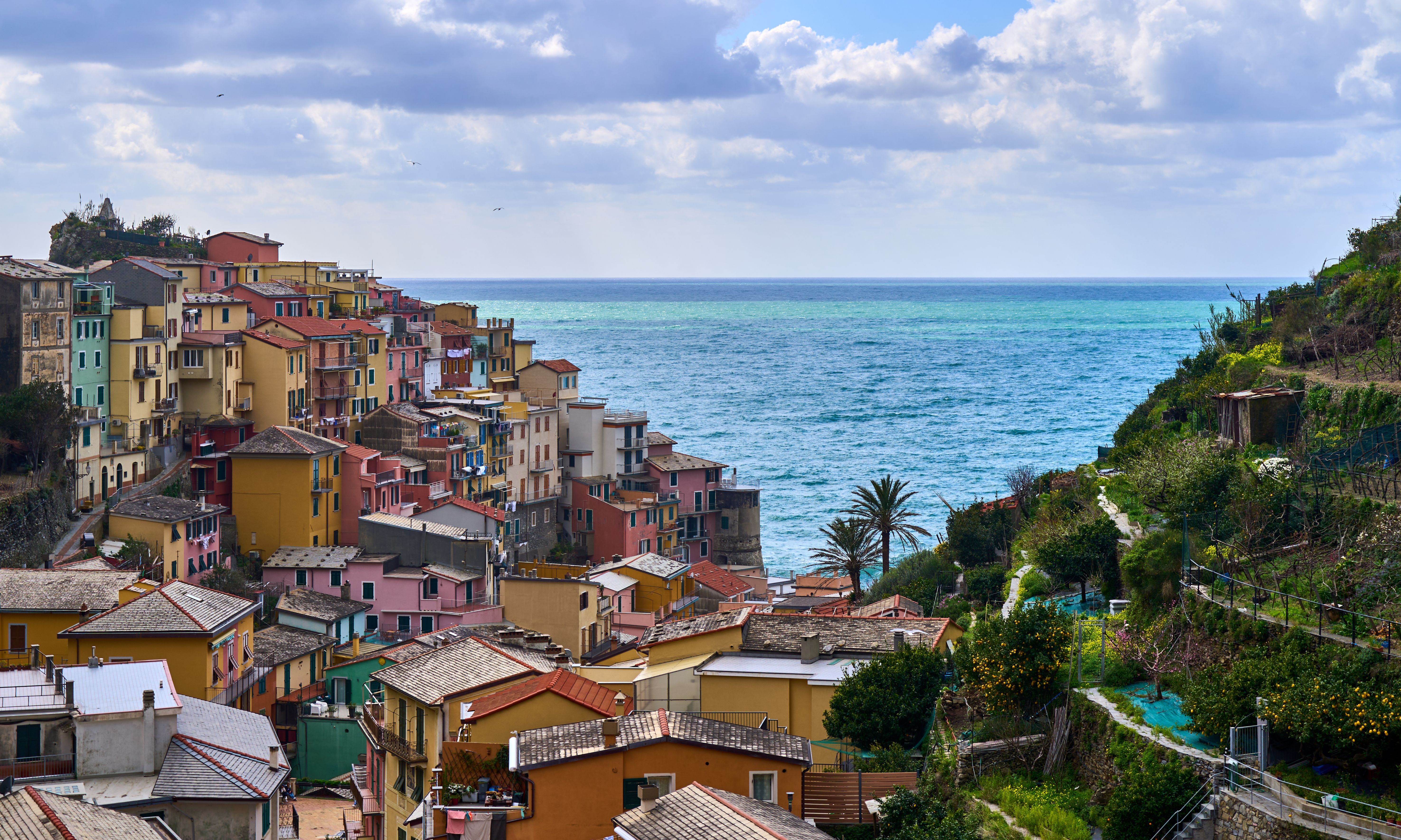 Colorful Coastal Village Overlooking Ocean · Free Stock Photo