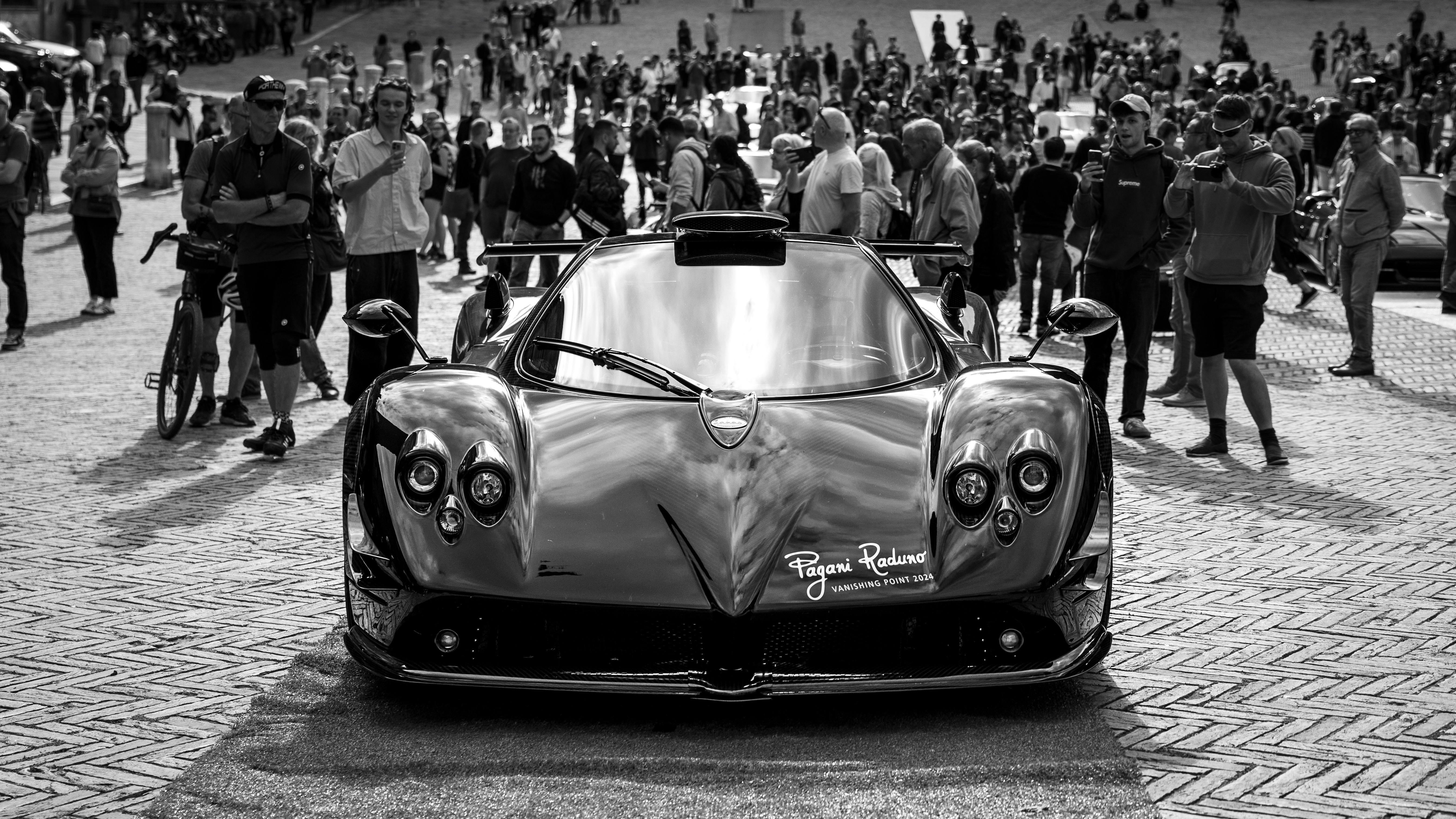 Elegant Black Pagani Car Amid Enthusiastic Crowd · Free Stock Photo