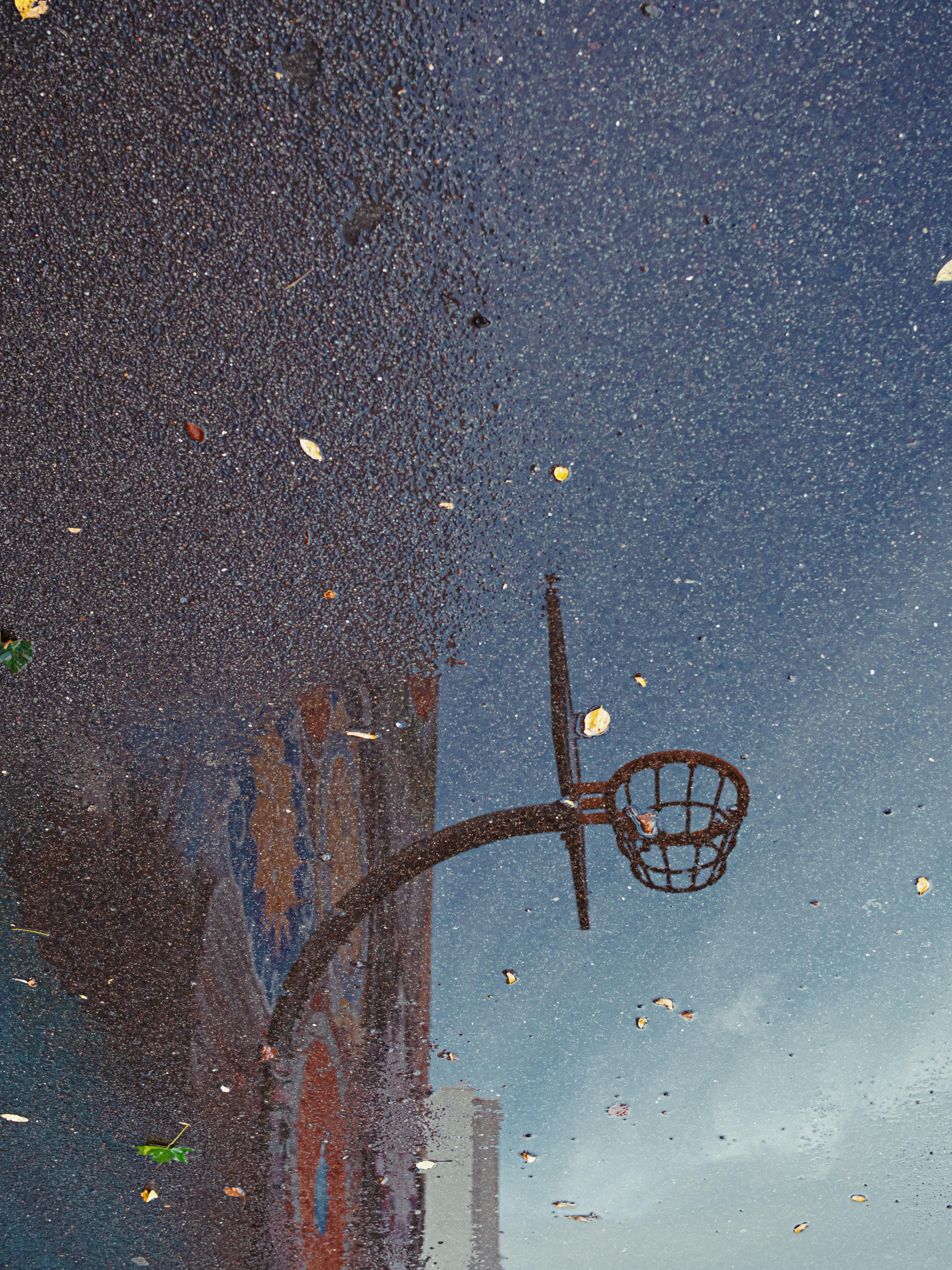 Reflection of Basketball Hoop on Wet Asphalt · Free Stock Photo