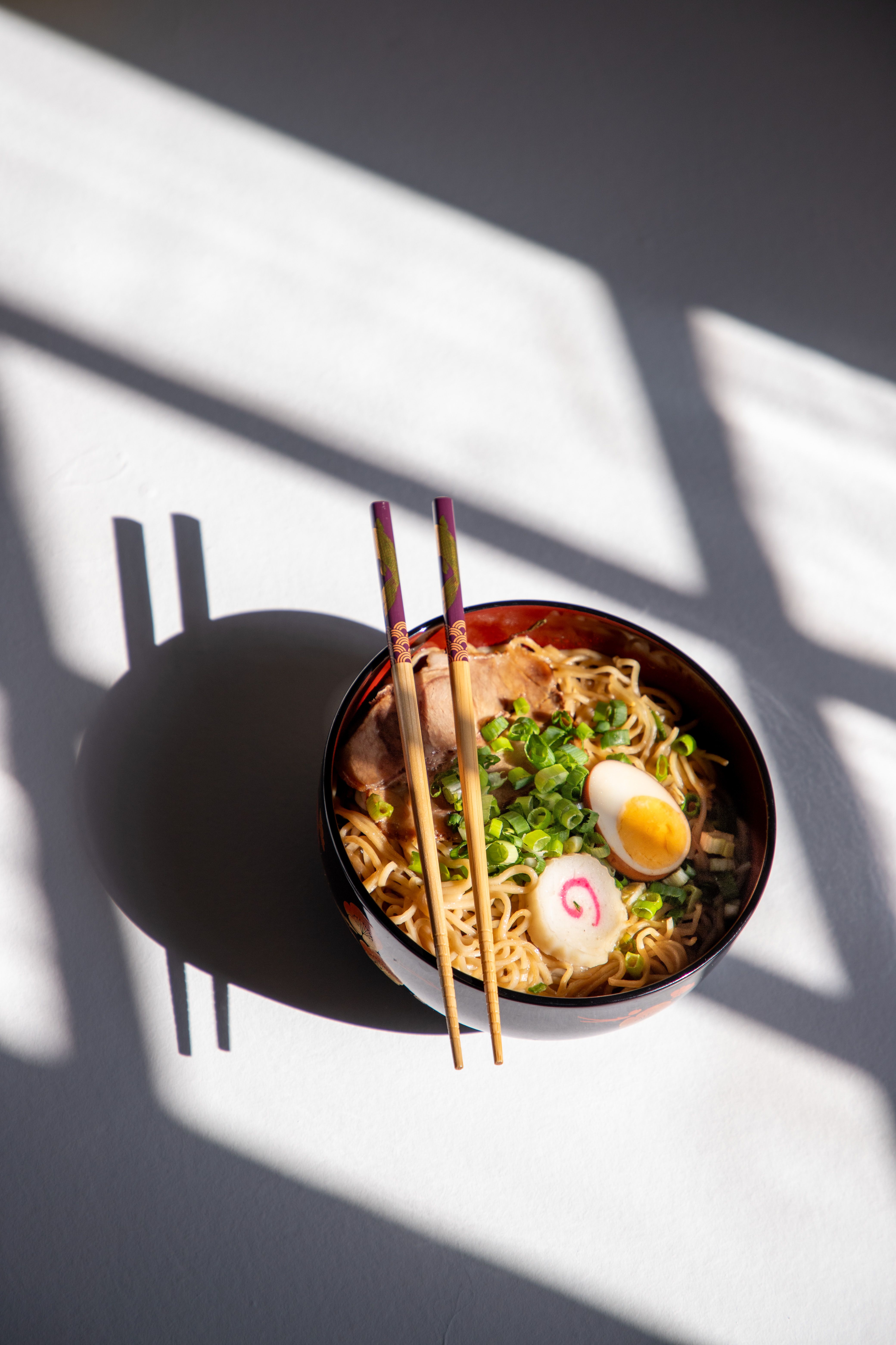 Delicious Ramen Bowl with Shadow Play · Free Stock Photo
