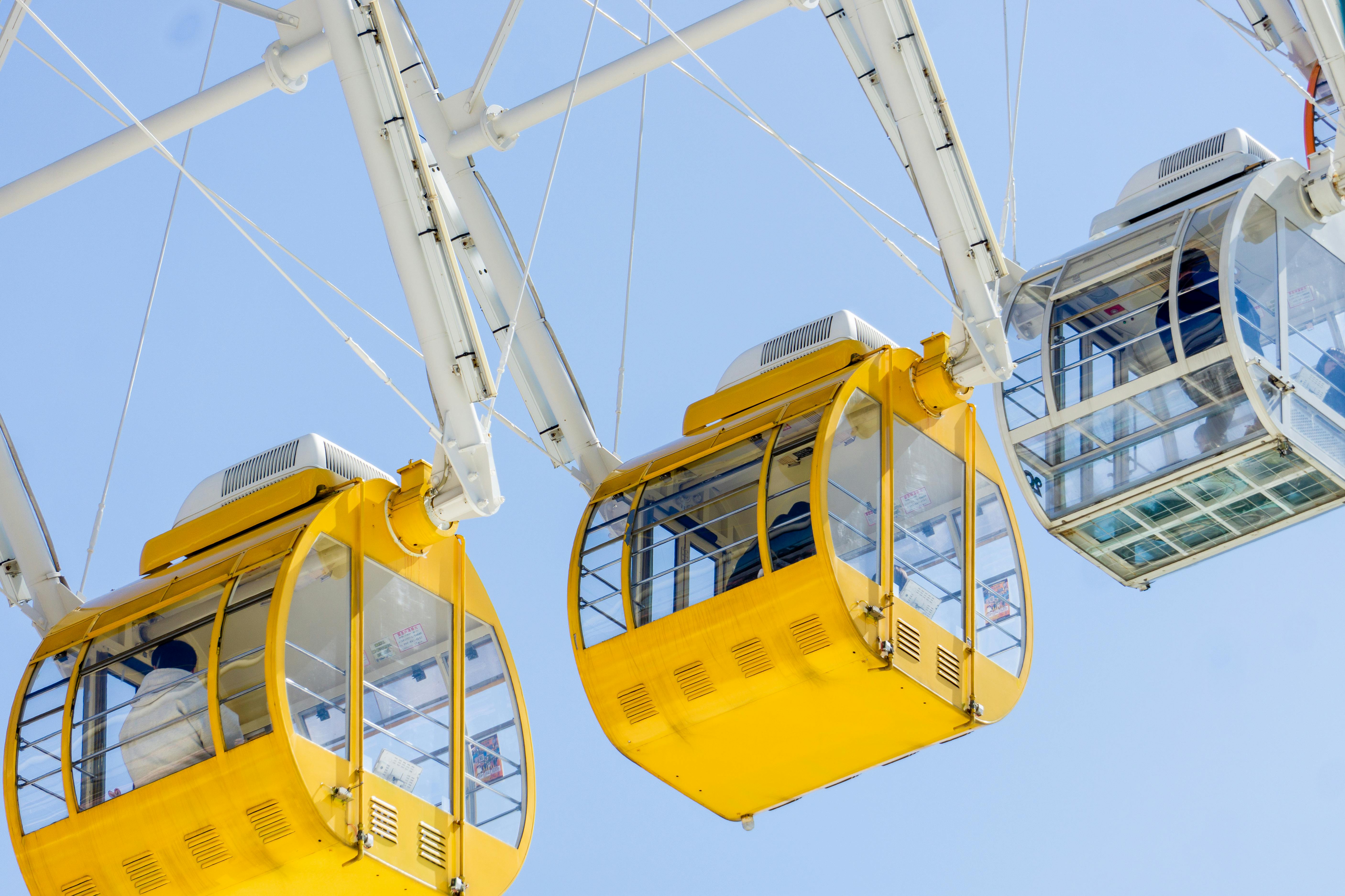 Yellow Ferris Wheel Cabins on a Clear Day · Free Stock Photo