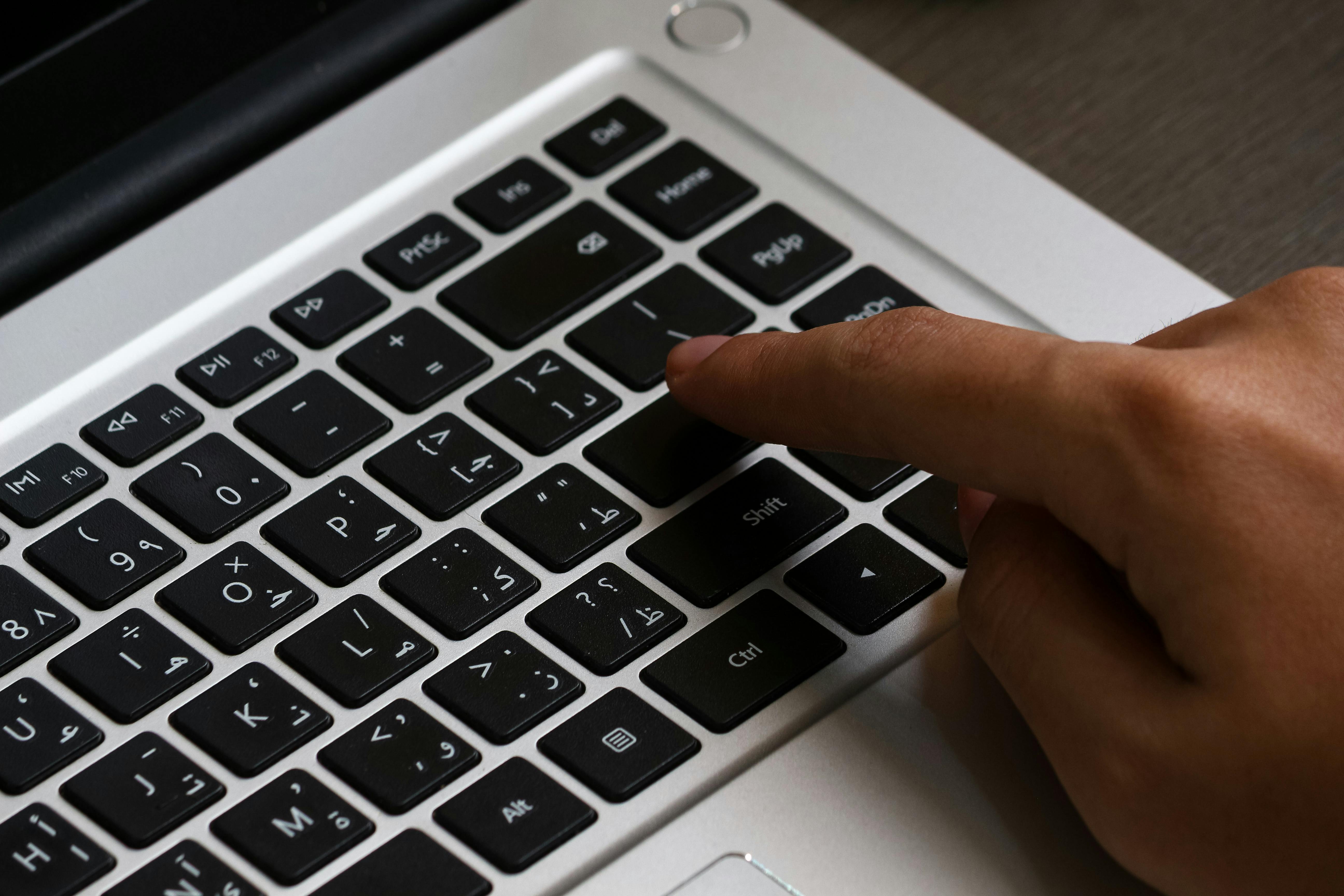 Typing on Keyboard with Arabic Text and Hands Close-up · Free Stock Photo