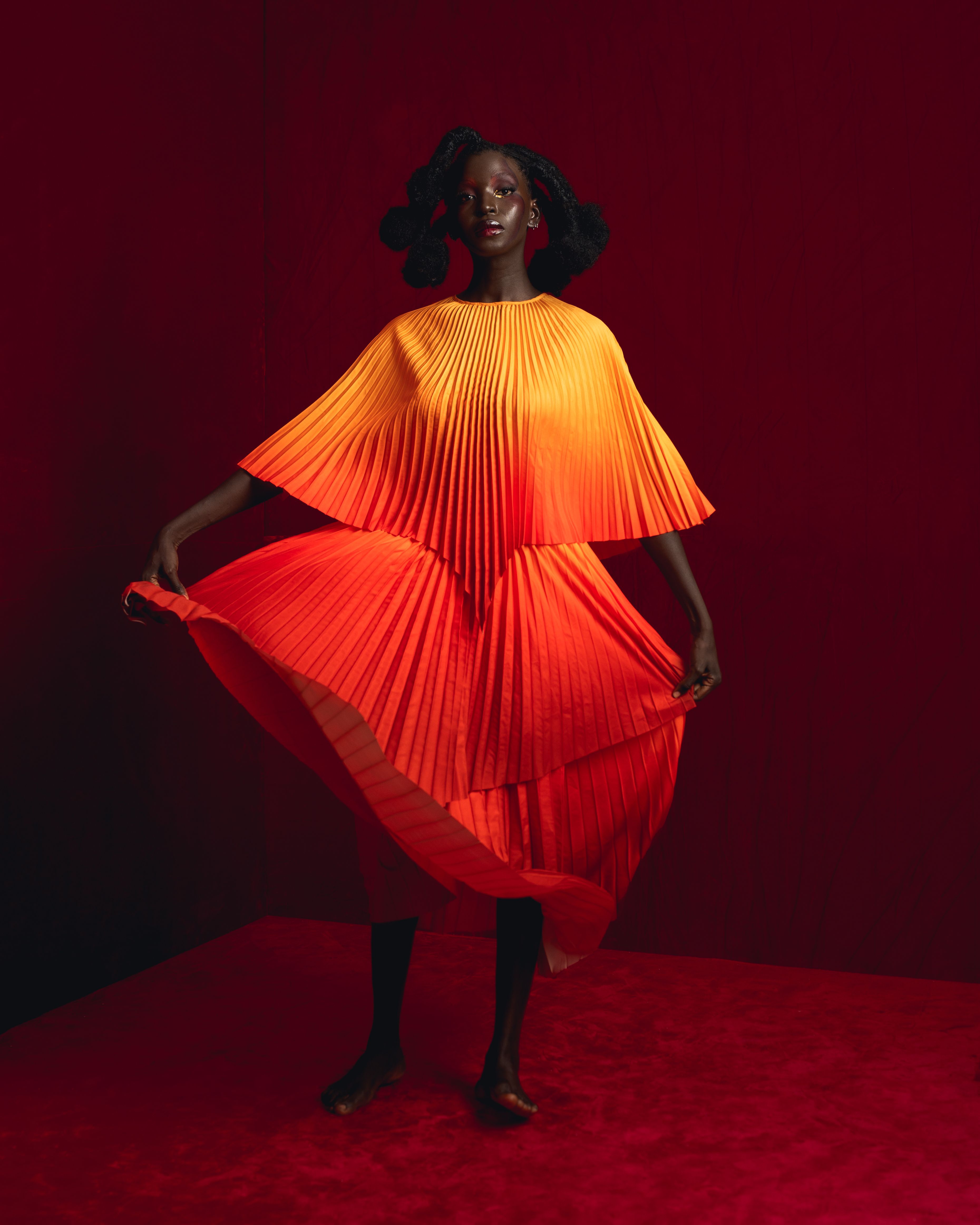 Elegant Model in Vibrant Orange and Red Dress · Free Stock Photo