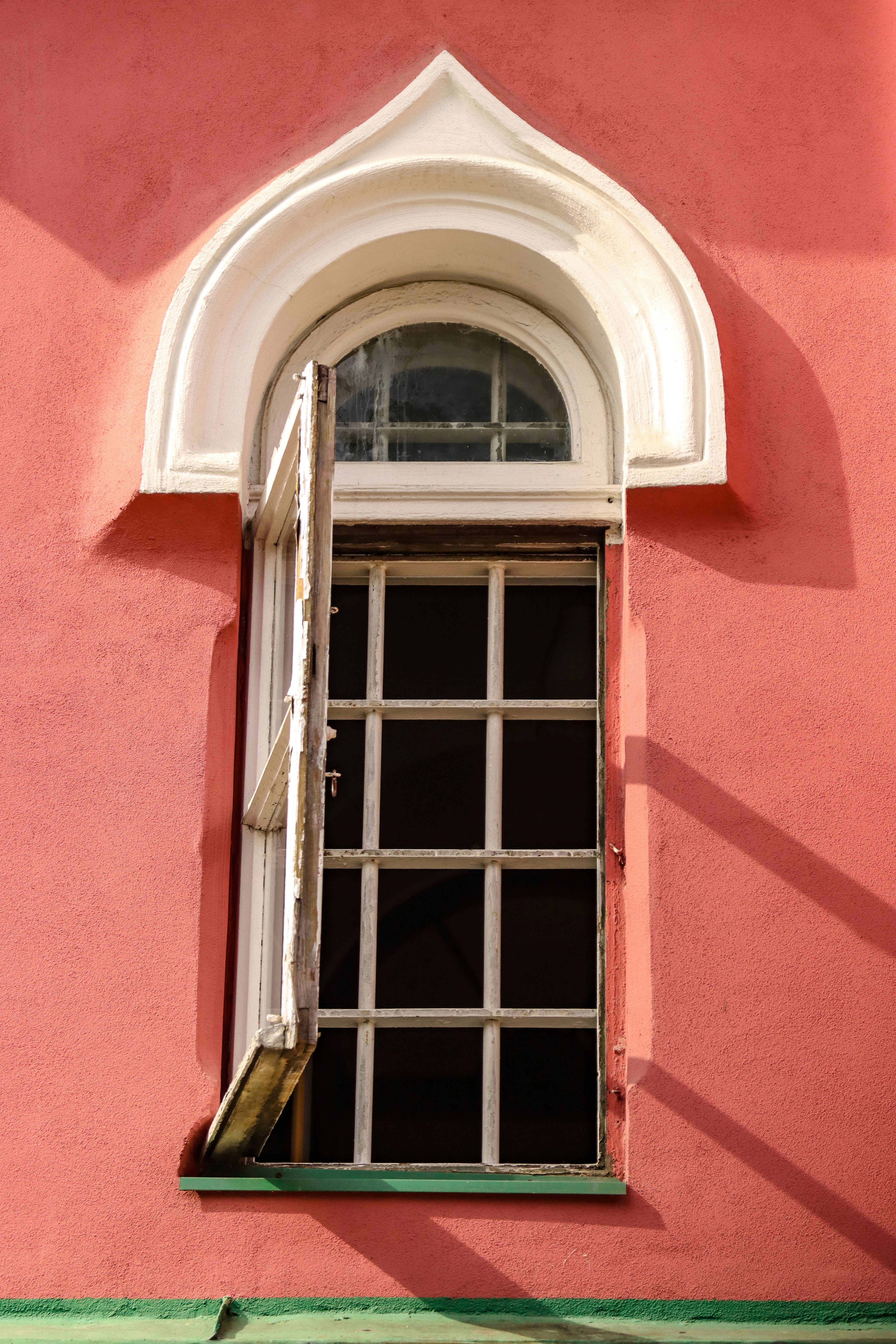 Open Arched Window on Vibrant Red Wall · Free Stock Photo