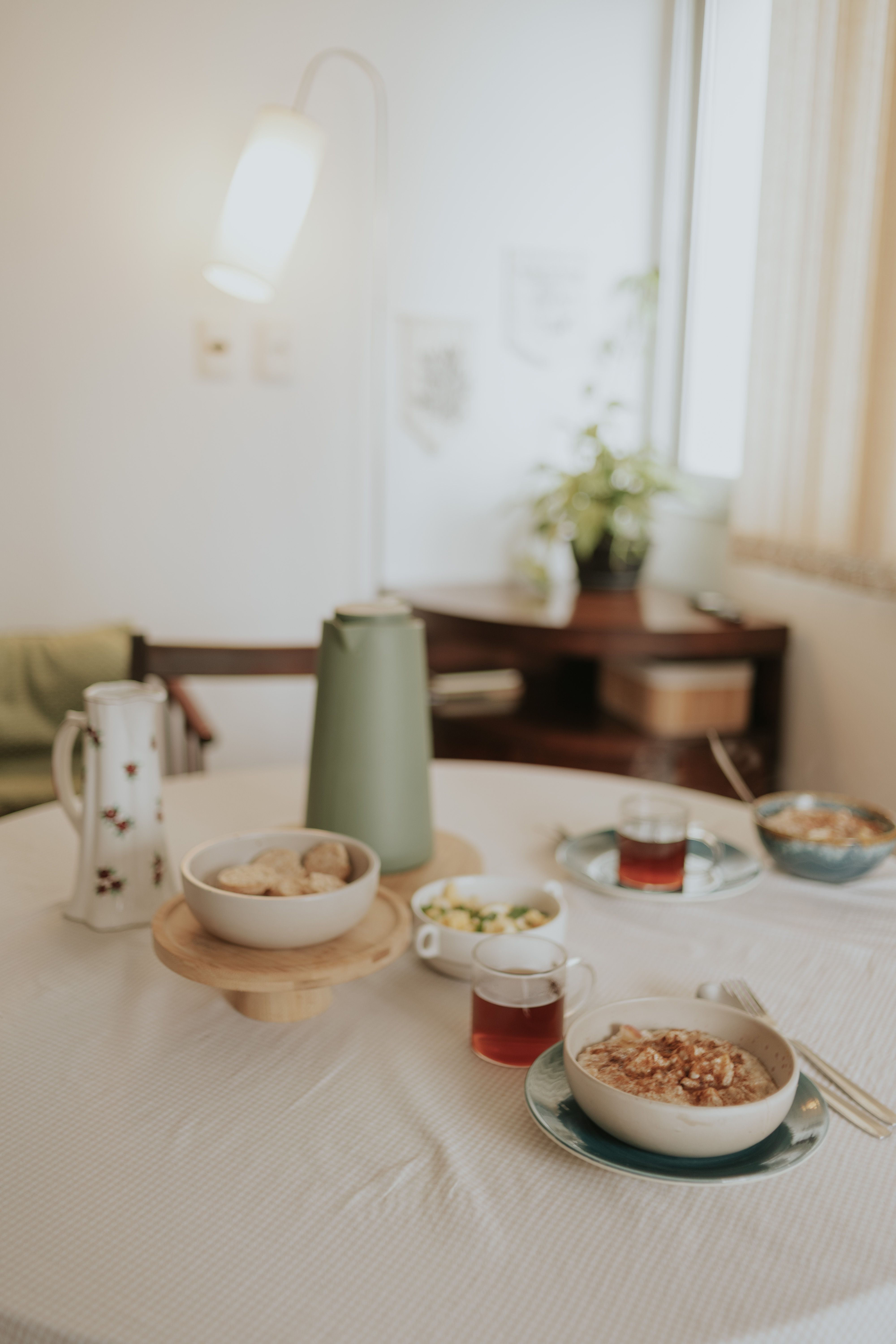 Cozy Breakfast Setting with Oatmeal and Tea · Free Stock Photo