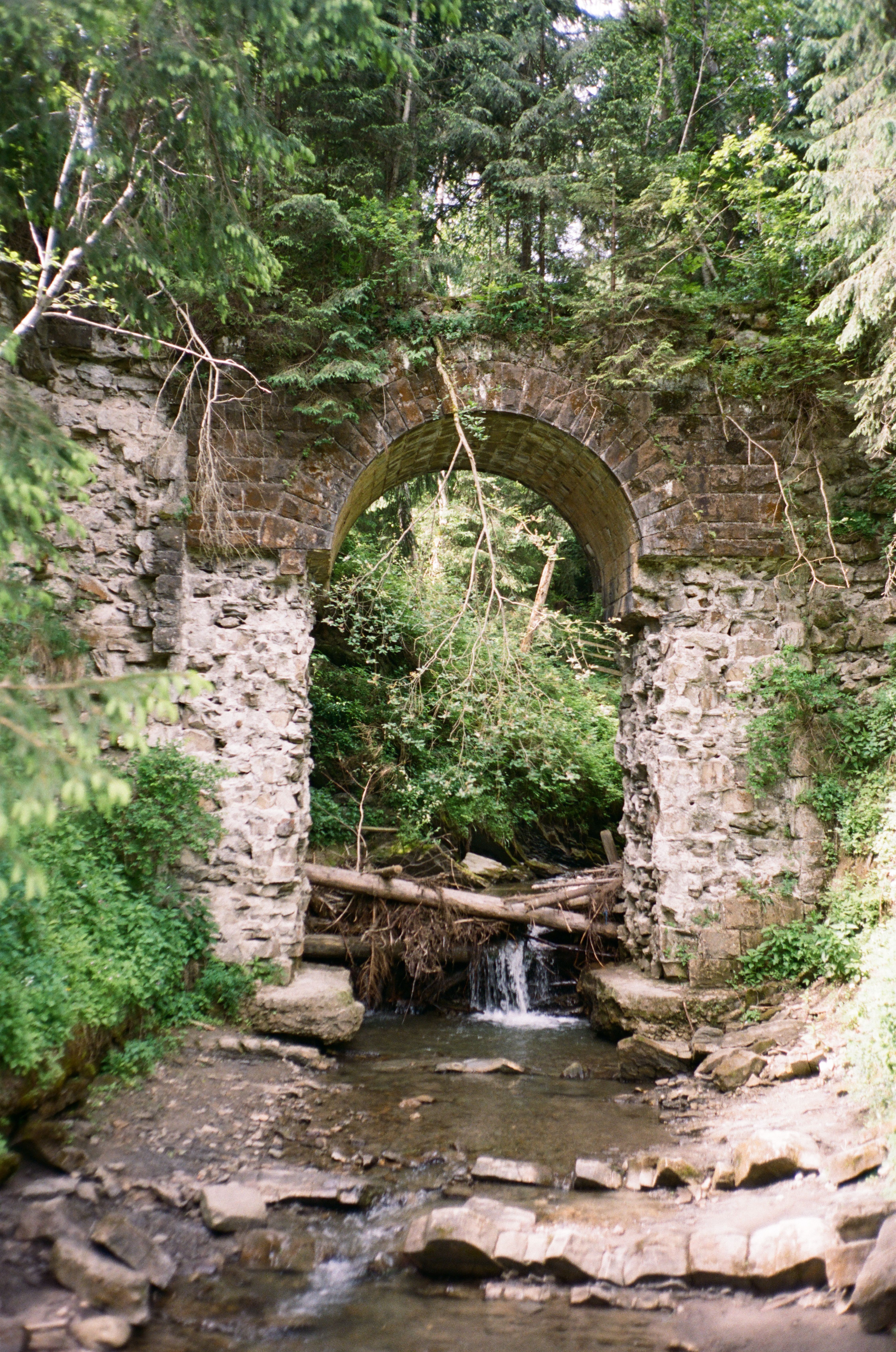 Stone Arch Bridge in Carpathian Forest Stream · Free Stock Photo
