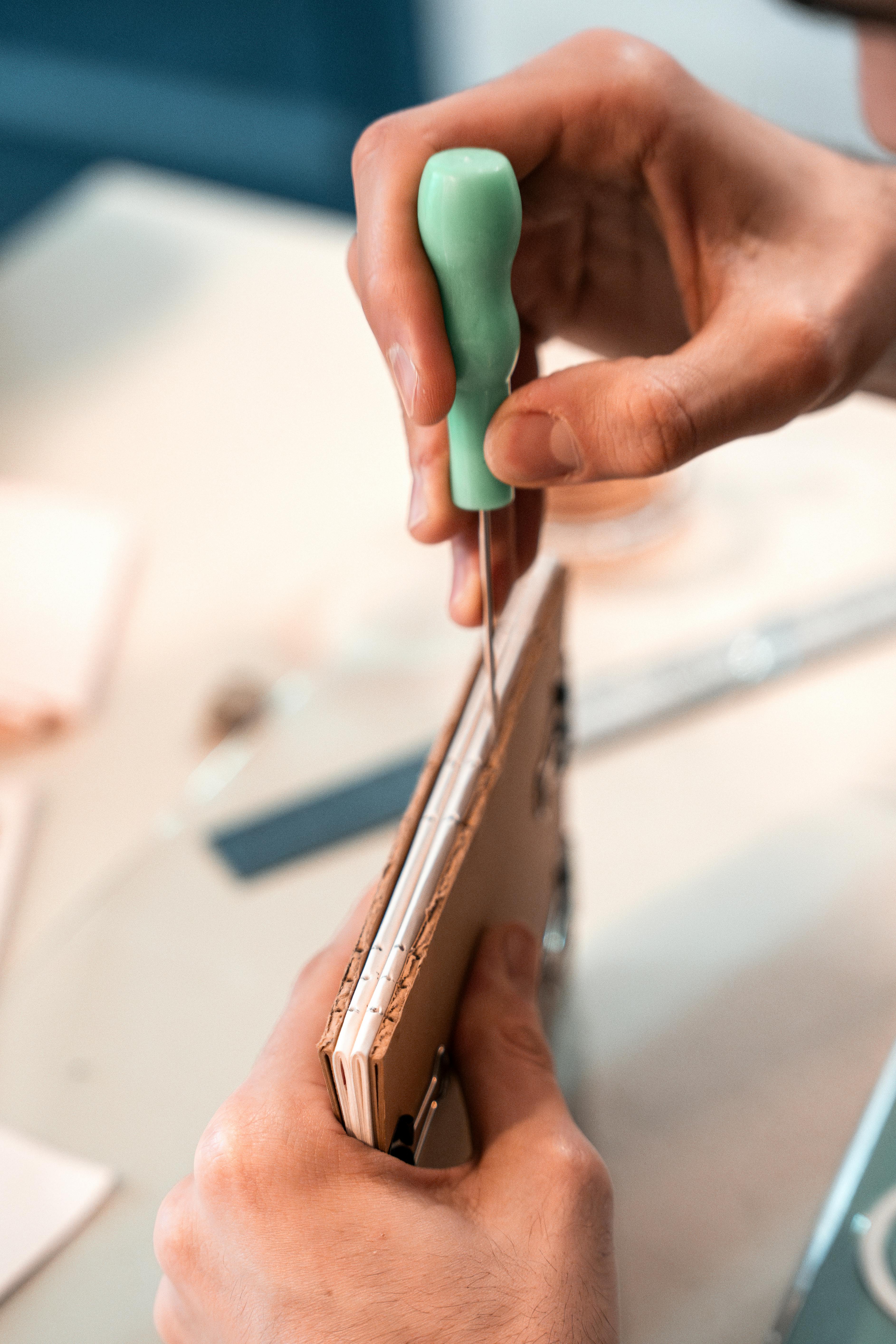 Close-up of Manual Bookbinding Process · Free Stock Photo