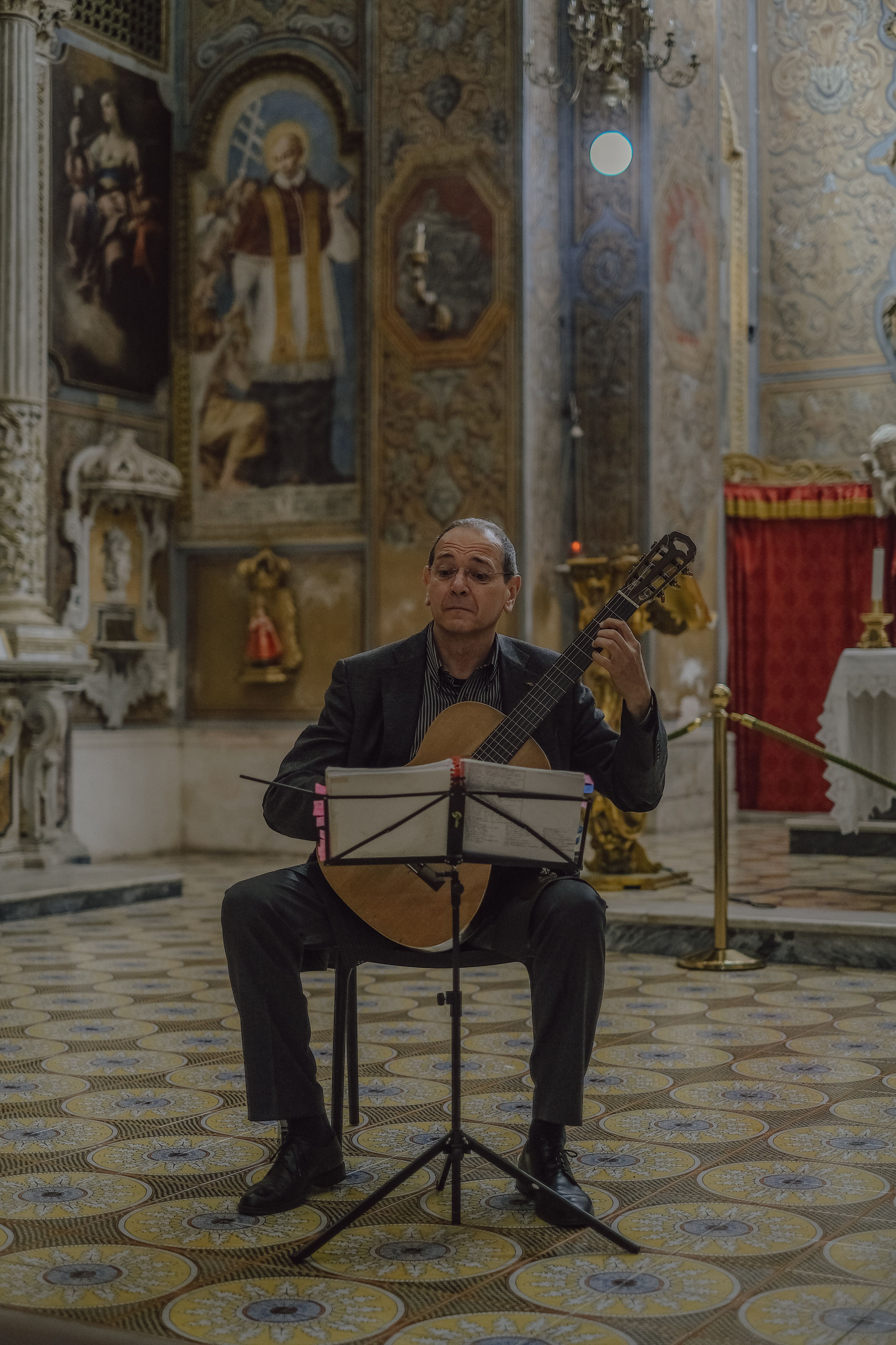 Classical Guitarist Performing in Ornate Cathedral · Free Stock Photo