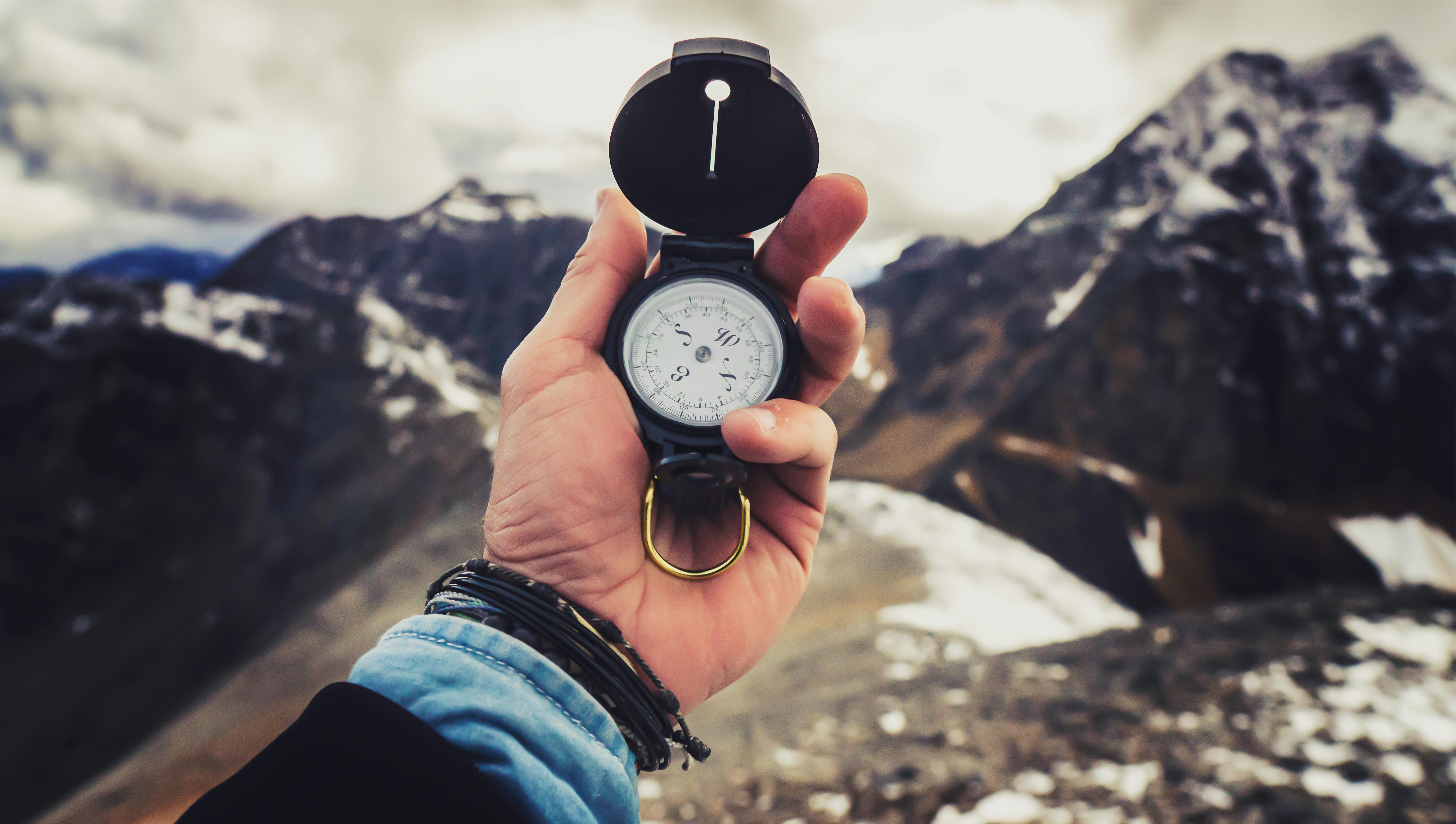 Person Wearing Black Leather Gloves Holding Brass-colored Compass ...