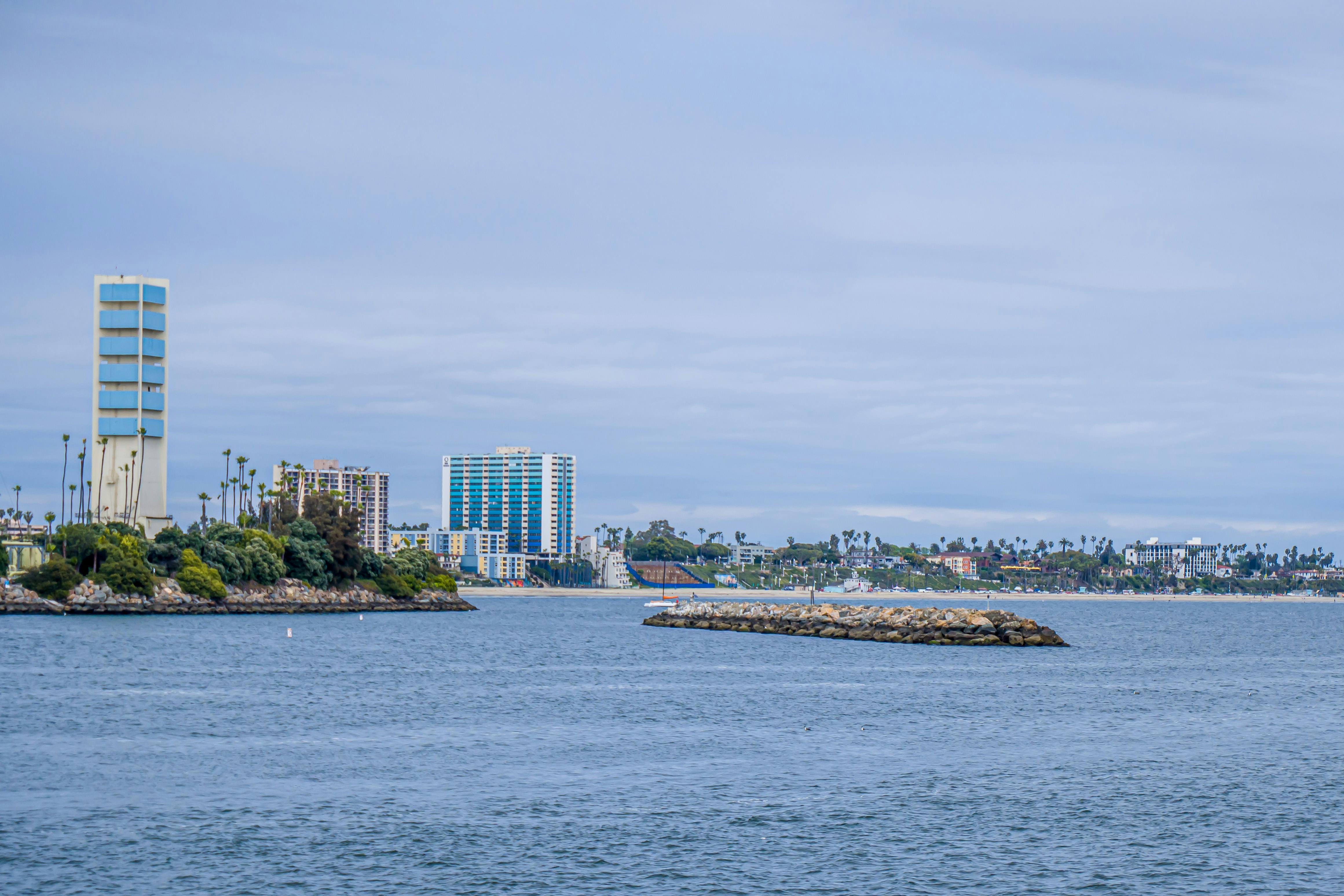 Coastal City Skyline with Ocean View and Buildings · Free Stock Photo