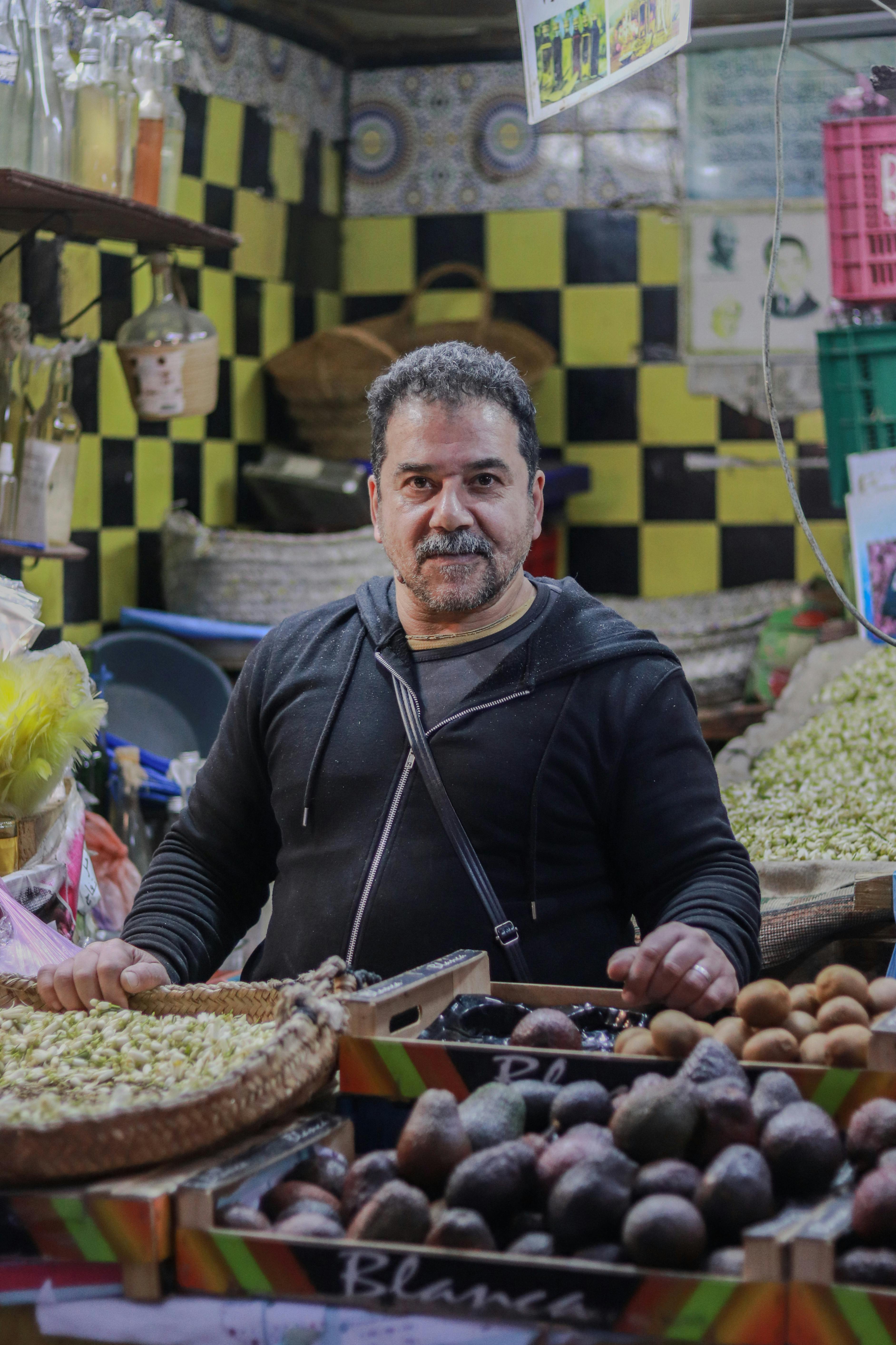 Portrait of a Vendor in a Local Market · Free Stock Photo