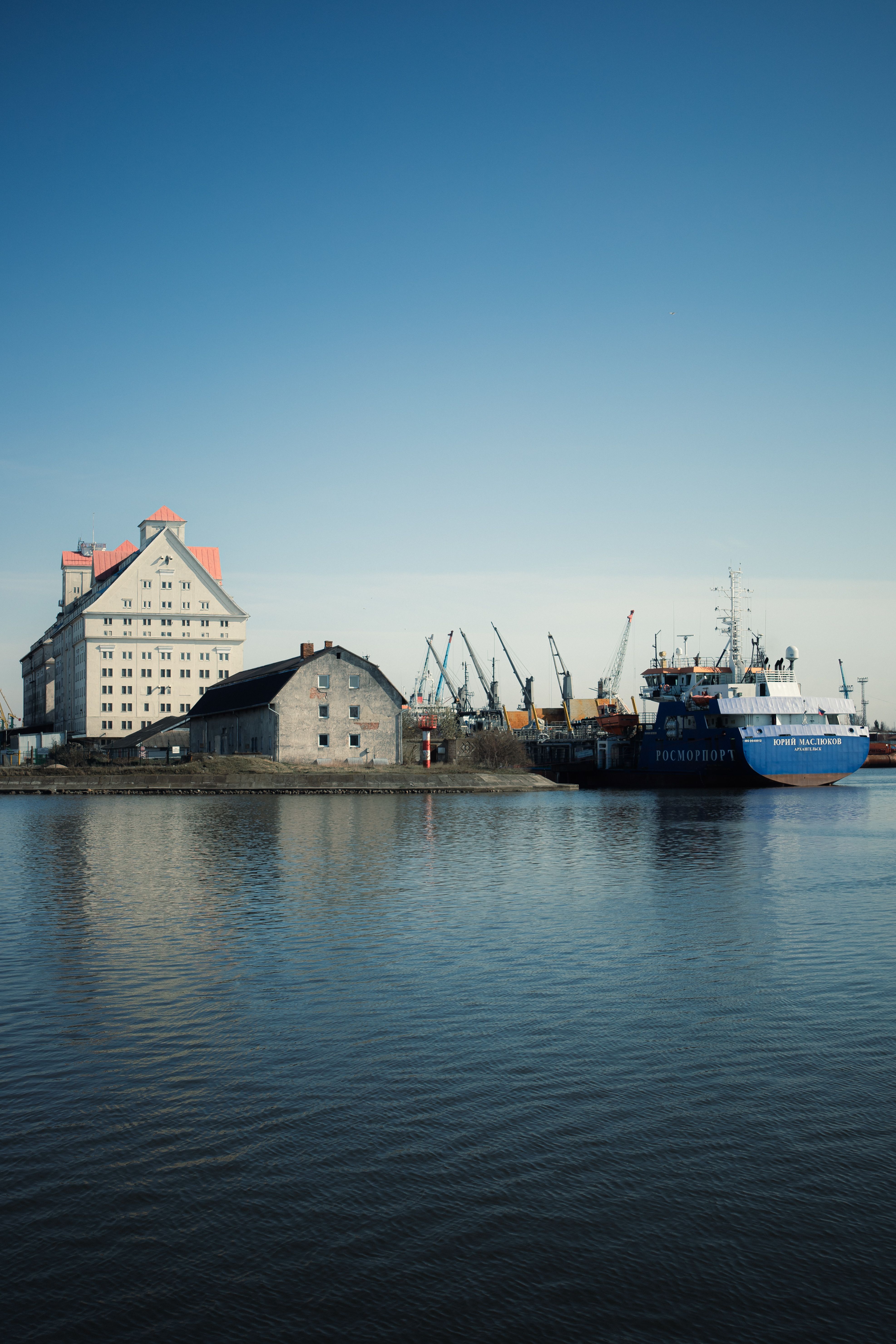 Scenic Port View with Historic Building and Ship · Free Stock Photo