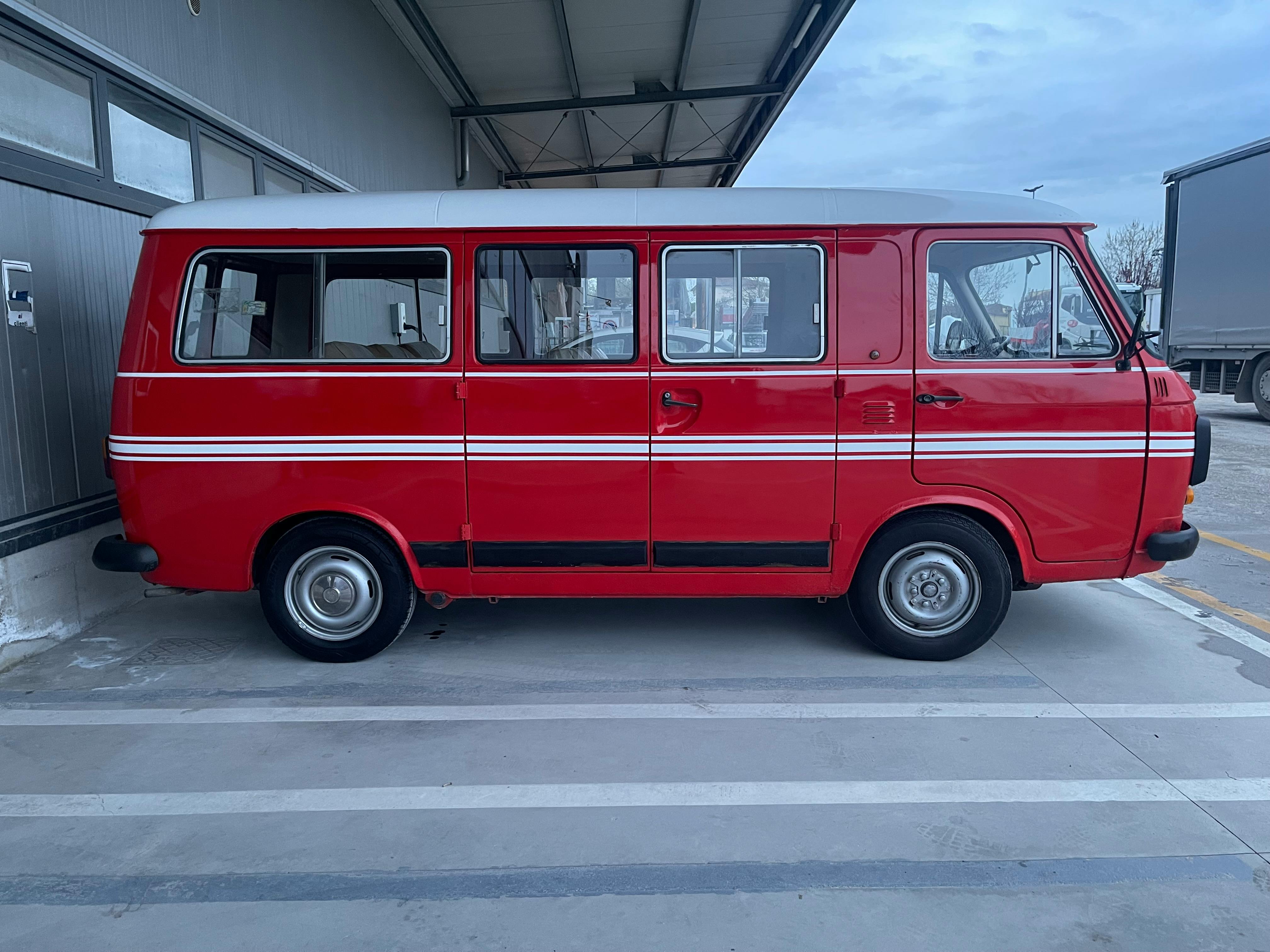 Vintage Red Minivan in Industrial Setting · Free Stock Photo