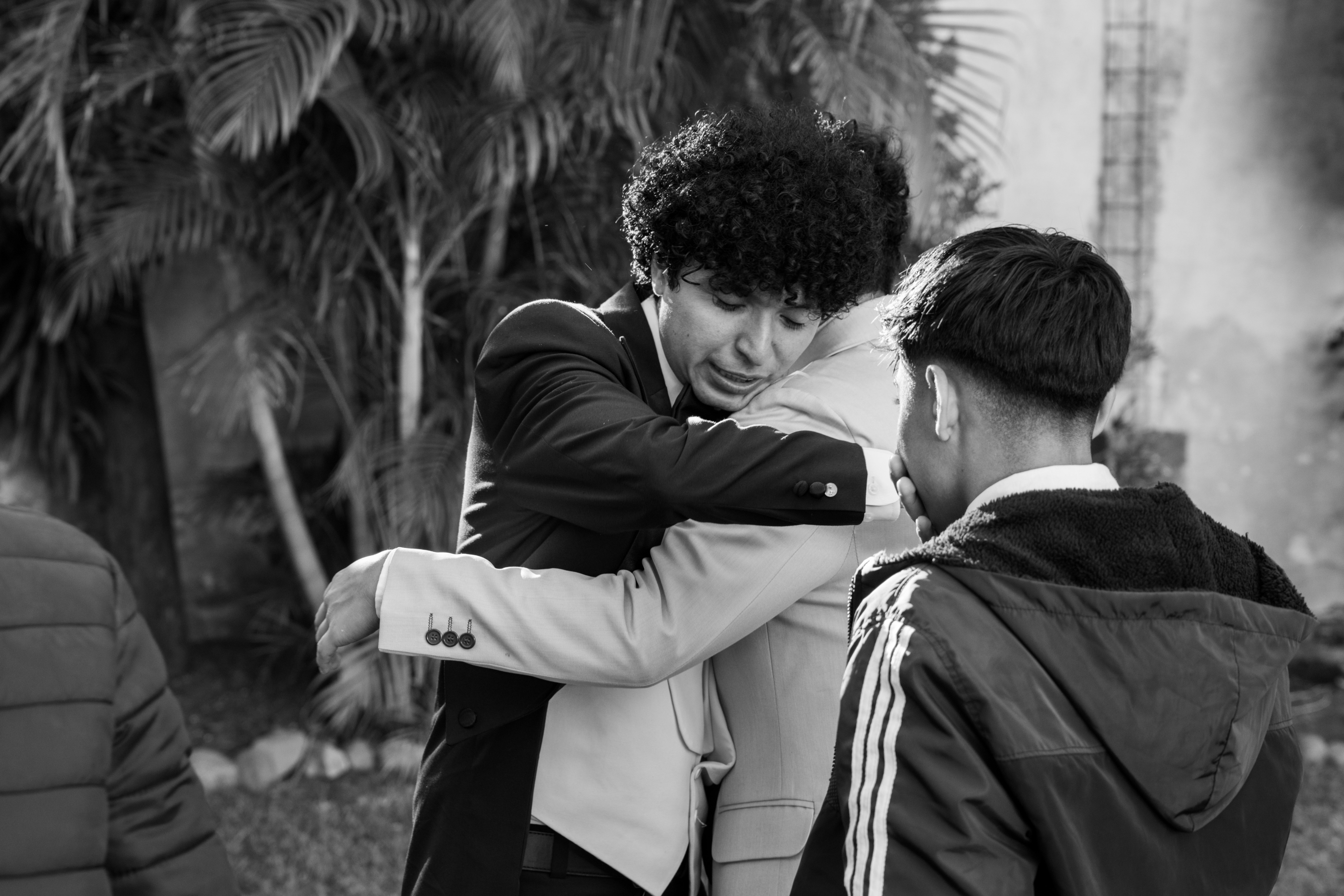Emotional Embrace Between Two Young Men Outdoors · Free Stock Photo