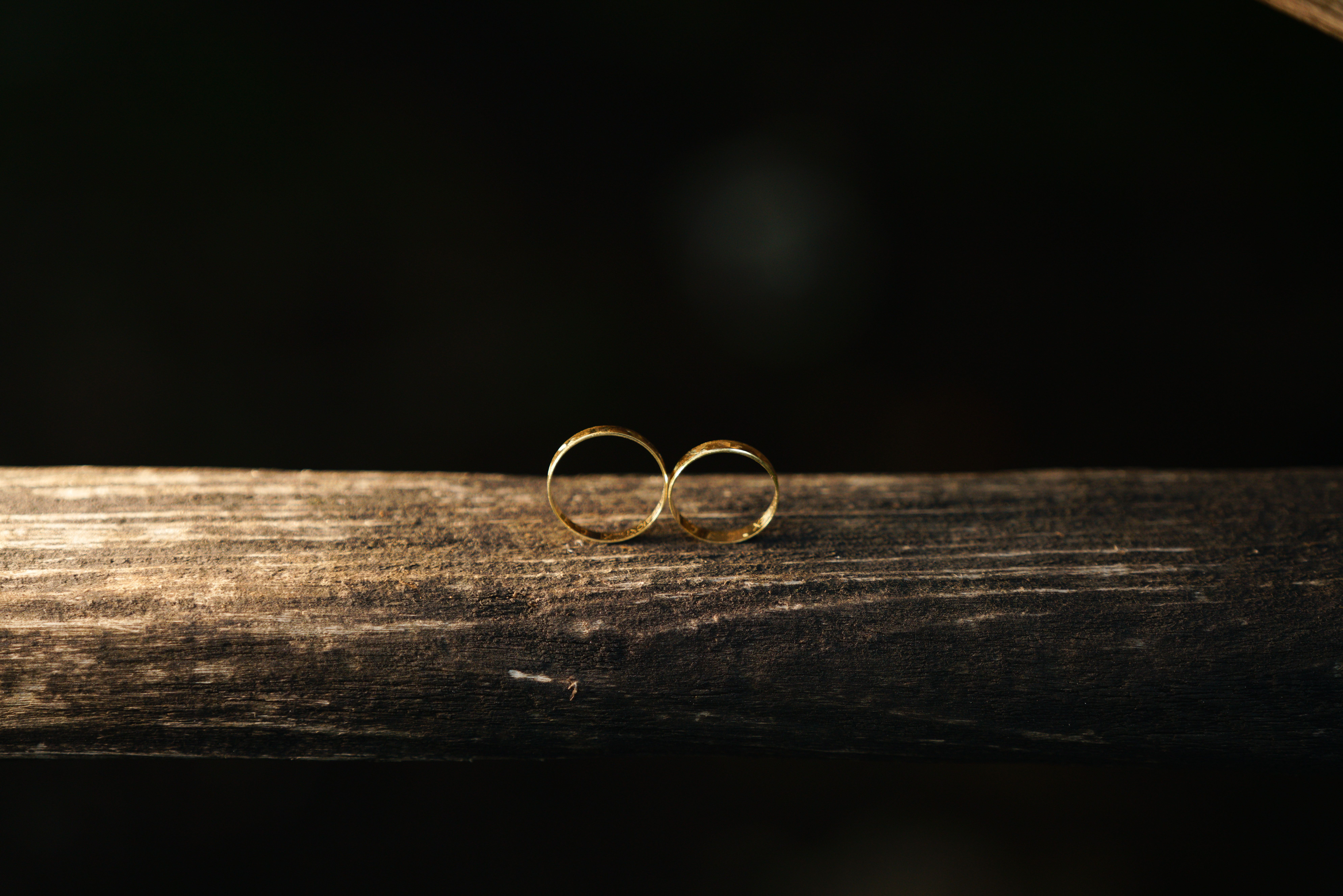 Elegant Gold Wedding Rings on Rustic Wood · Free Stock Photo